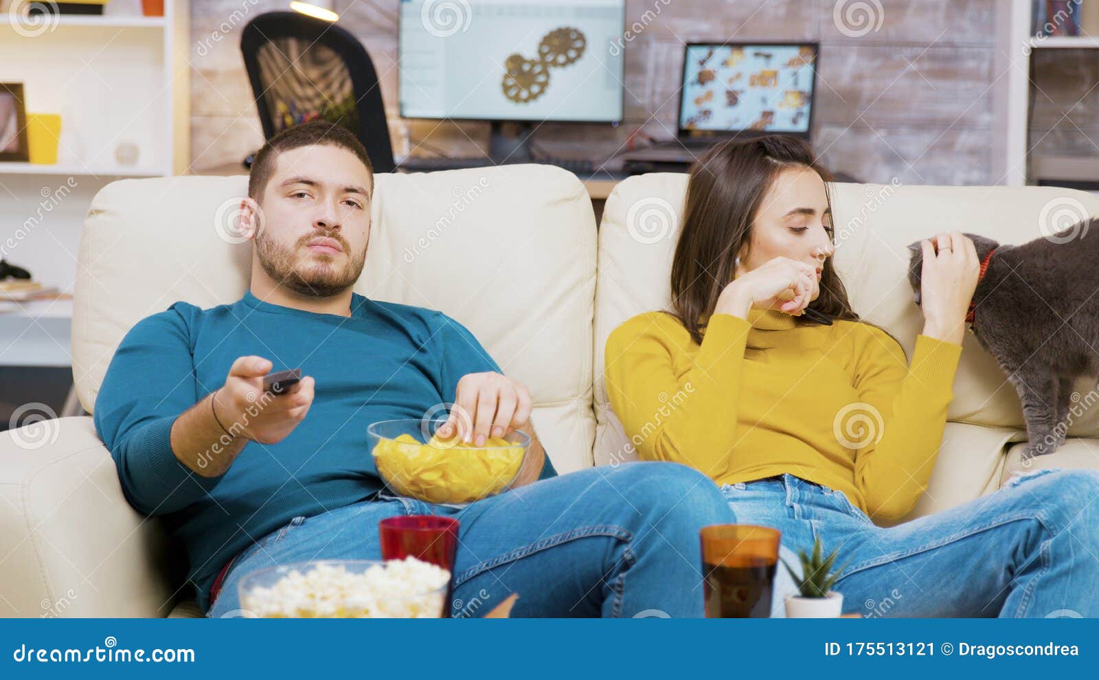 Bearded Man Eating Chips and Using Remote Control To Change Tv Channels ...