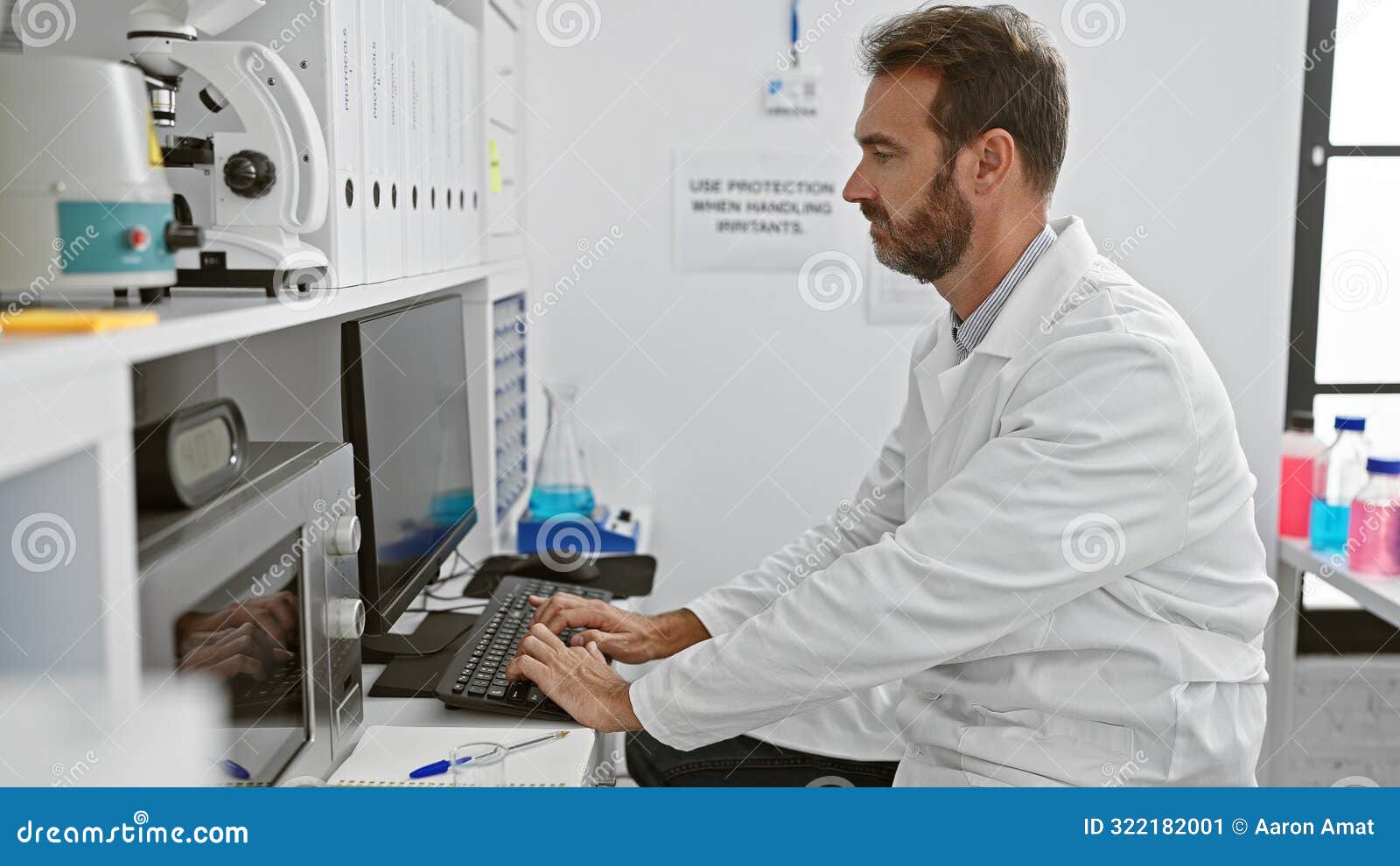 Bearded Man in Lab Coat Working at Computer in Modern Laboratory ...
