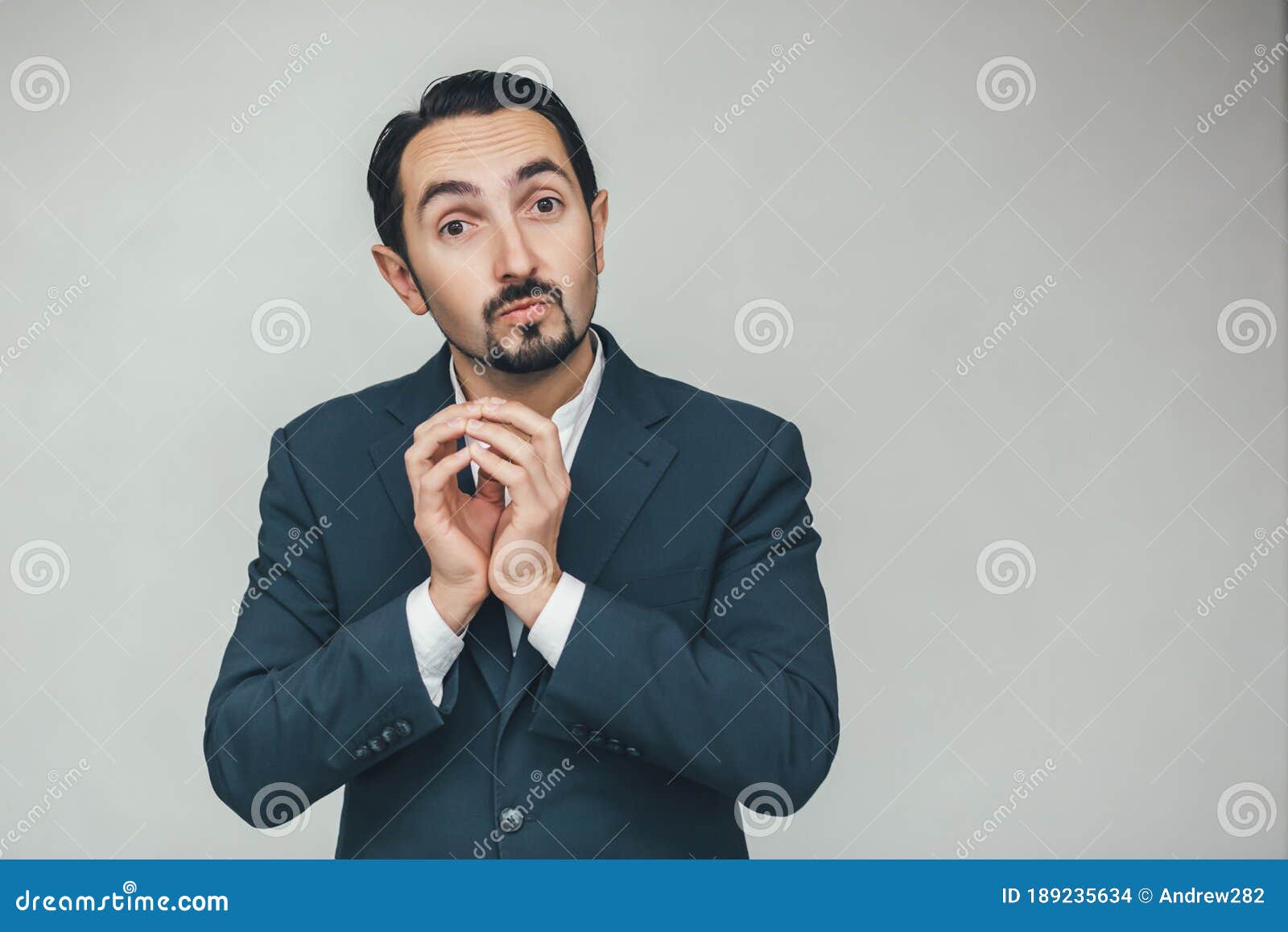 Bearded Man is Looking with Suspicion Expression, Tapping His Fingers ...