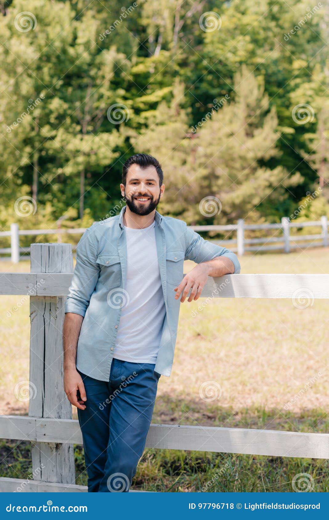 Bearded Man Standing at Wooden Fence and Looking at Camera Stock Photo ...