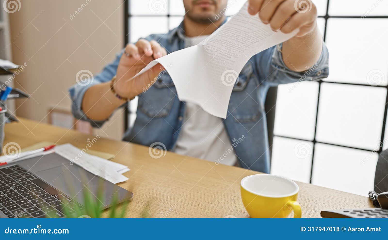 A Bearded Man Tearing Paper in an Office, Expressing Frustration or ...