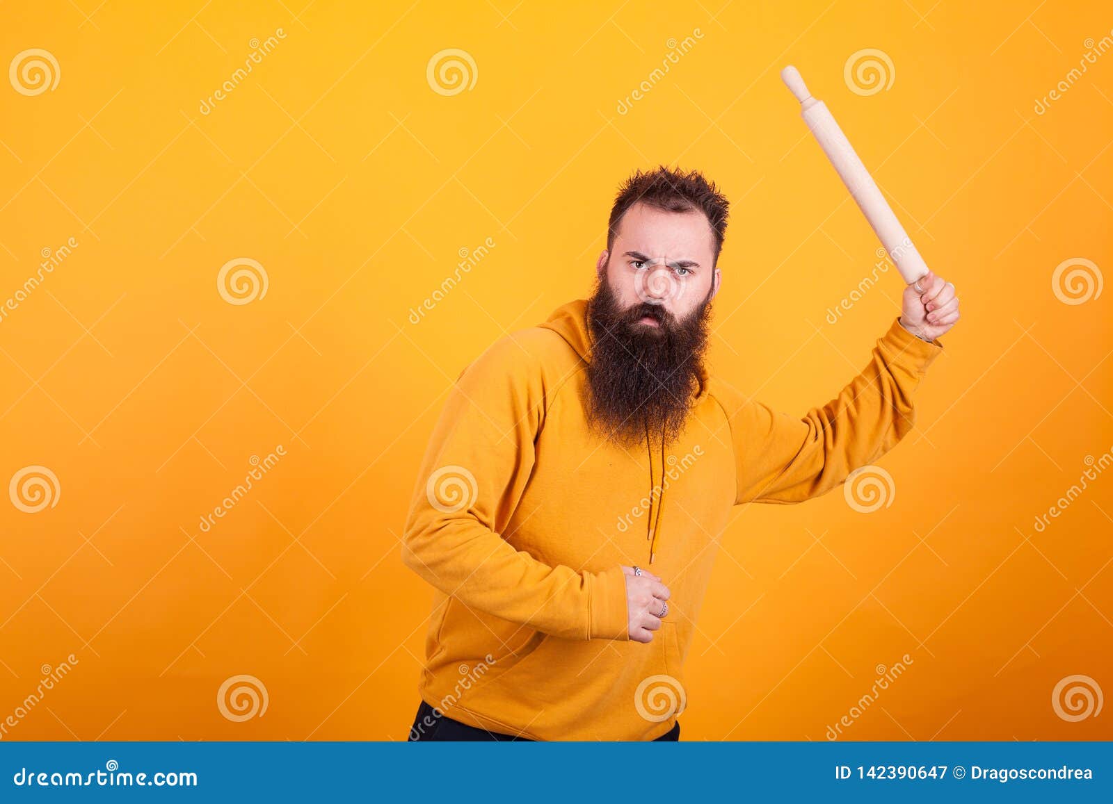 Bearded Man Using Paddle As If Was a Baseball Bat Over Yellow ...