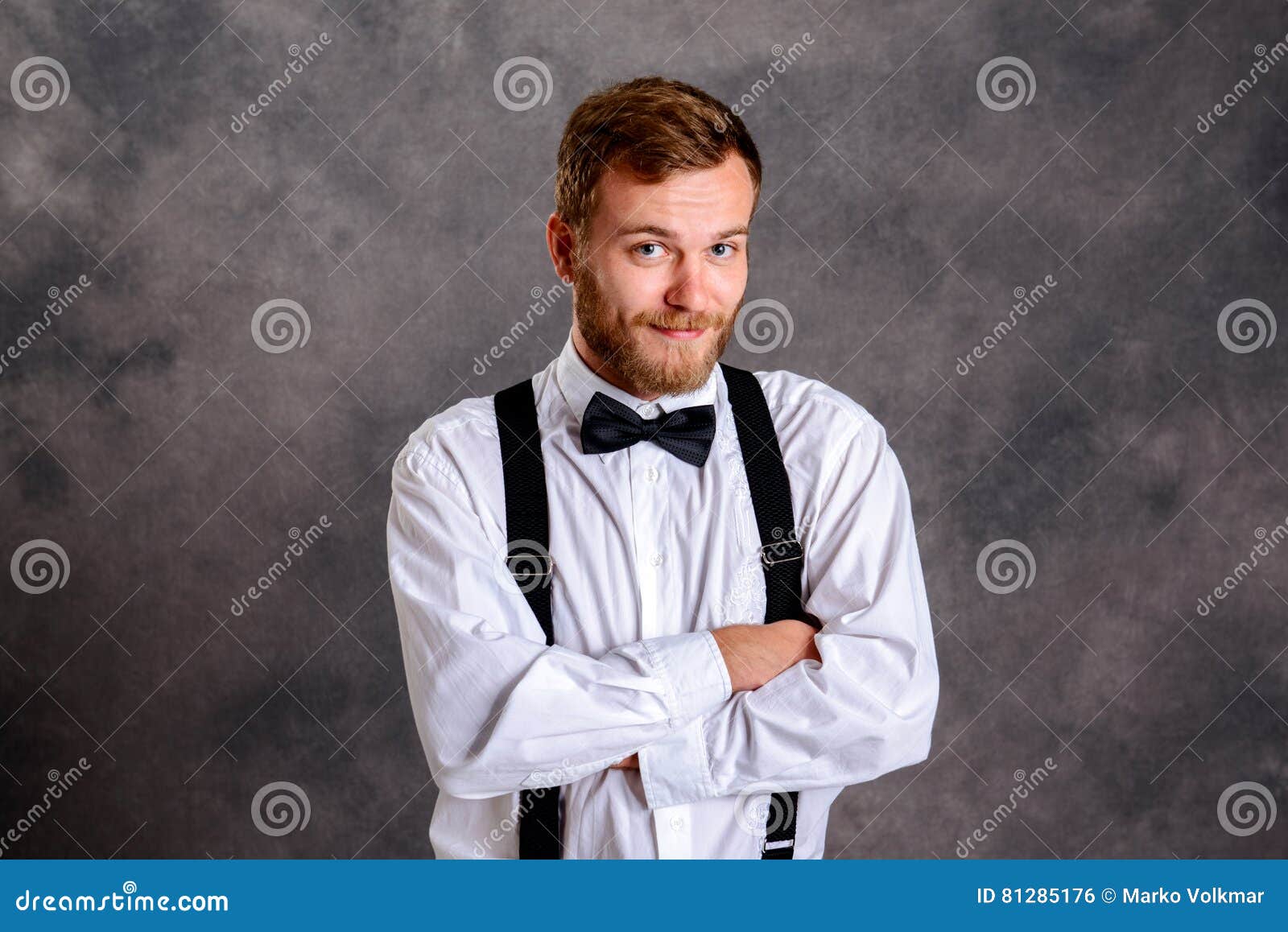 Bearded Man In White Shirt And Bow Tie In Front Of Gray Backgro Stock