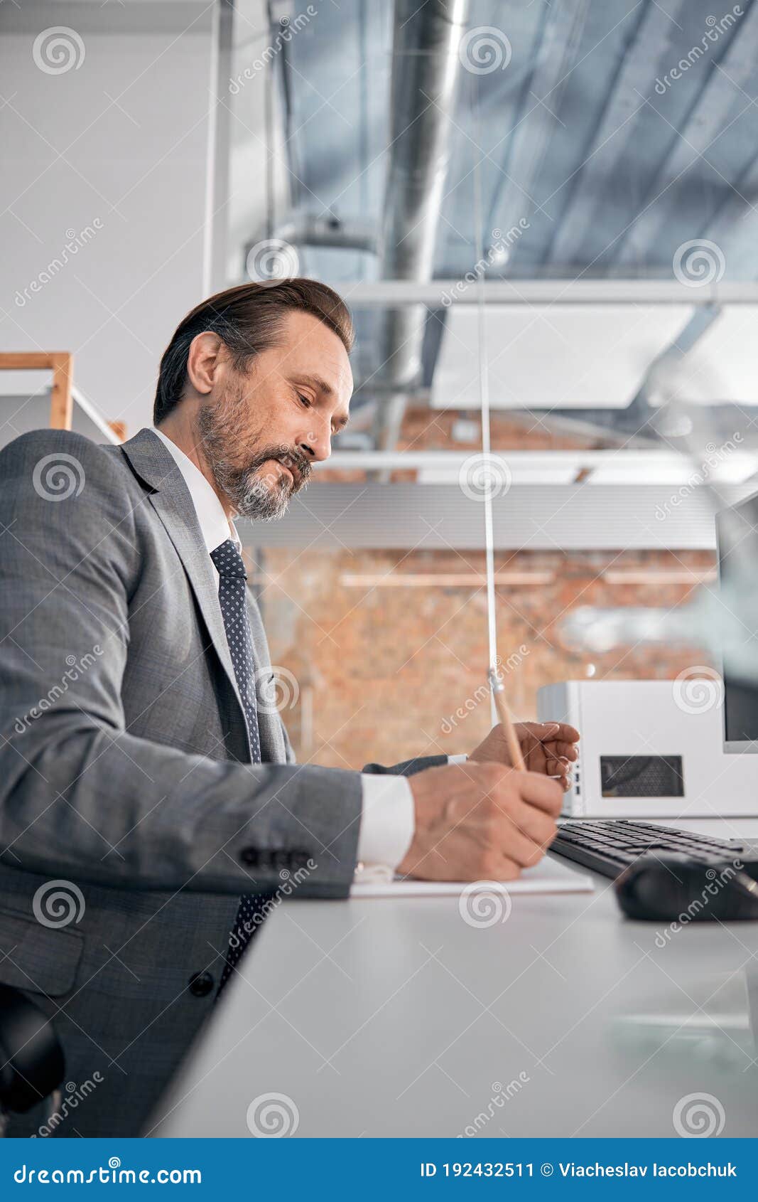 Bearded Man Writing in Notebook at Work Stock Image - Image of bearded ...