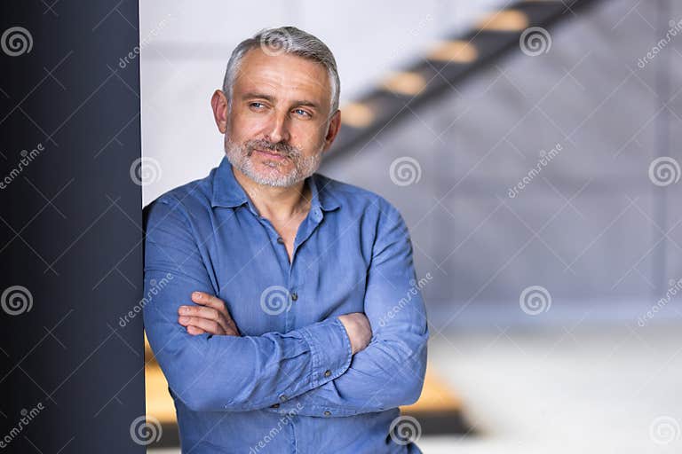 Bearded Middle Aged Man With A Serious Expression In A Close Up Head And Shoulders Portrait