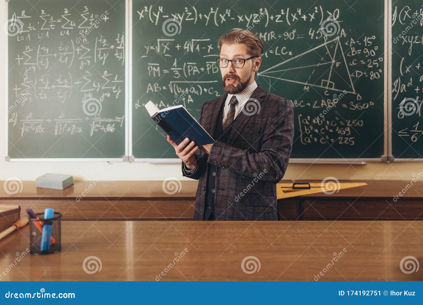 Bearded Professor At School Lesson At Desks In Classroom. Back To ...