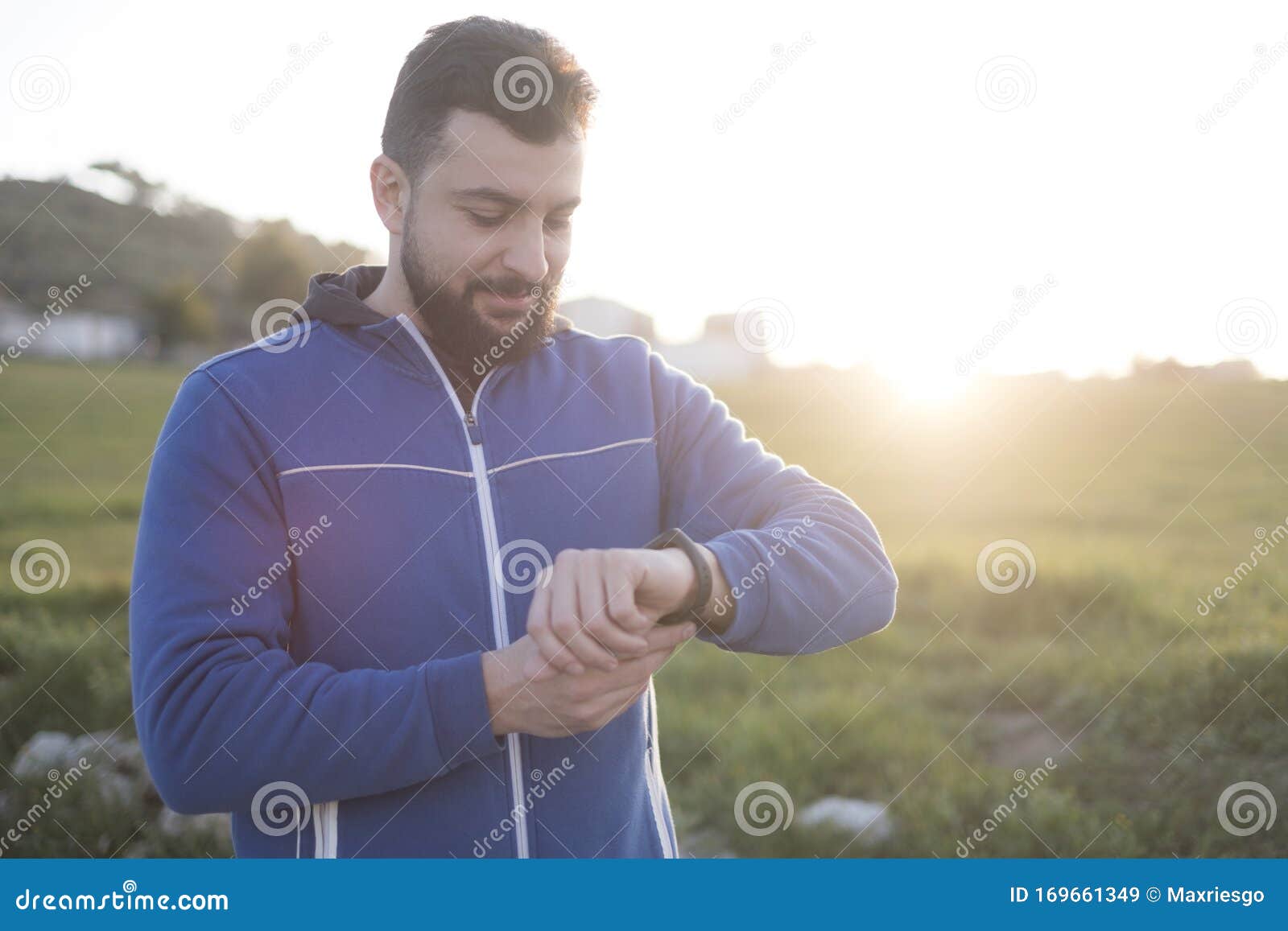 Bearded Runner Resting after Training Outdoors Looking Smart Watch ...