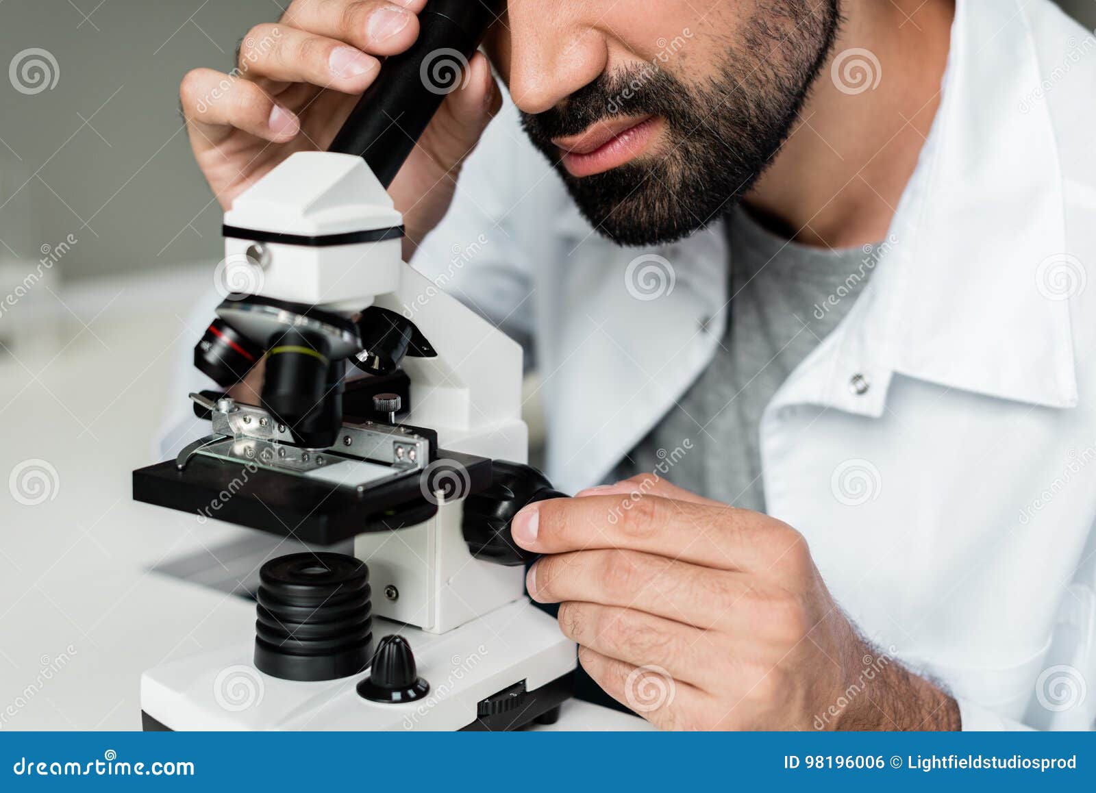 Bearded Scientist in White Coat Working with Microscope in Lab Stock ...