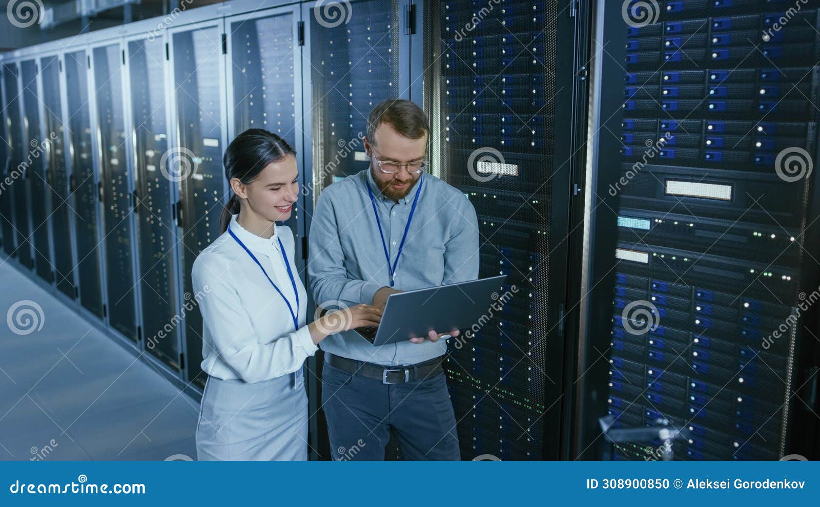 Bearded it Technician in Glasses with a Laptop Computer and Beautiful ...