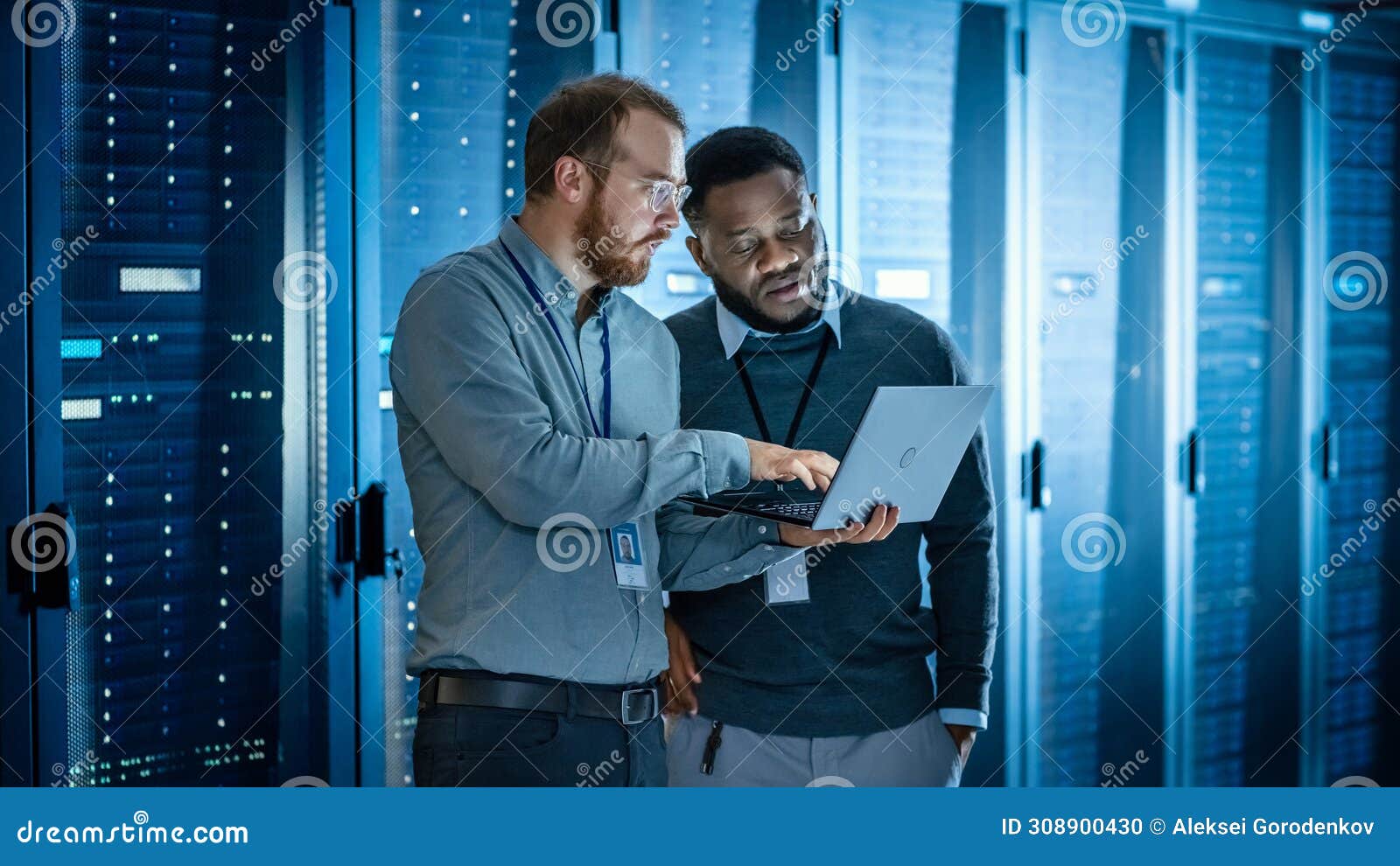 Bearded it Technician in Glasses with Laptop Computer and Black Male ...