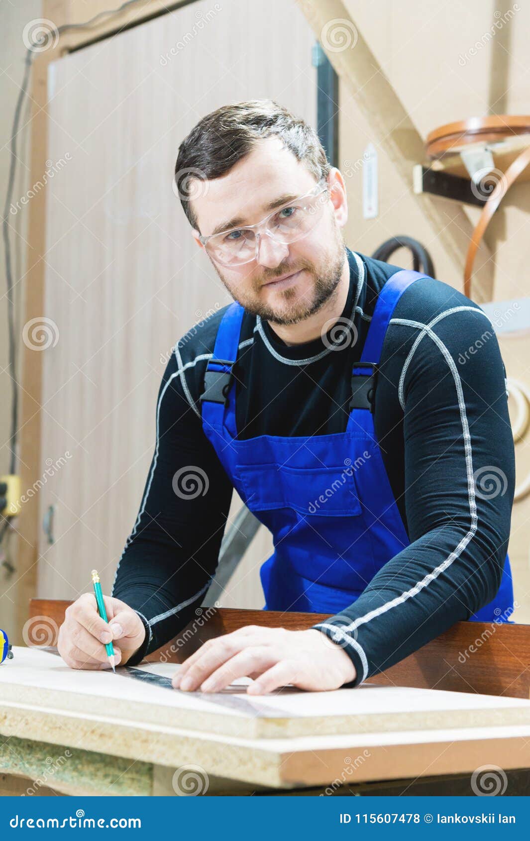 A Bearded Tired Handsome Carpenter on a Table with a Pencil Draws a ...