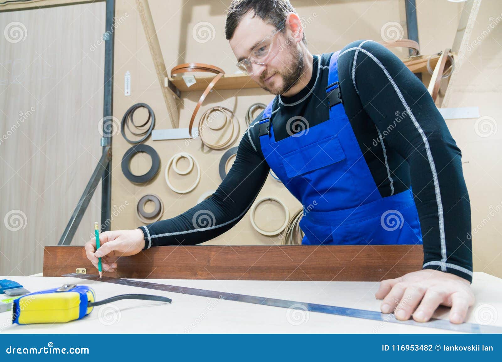 A Bearded Tired Handsome Carpenter on a Table with a Pencil Draws a ...