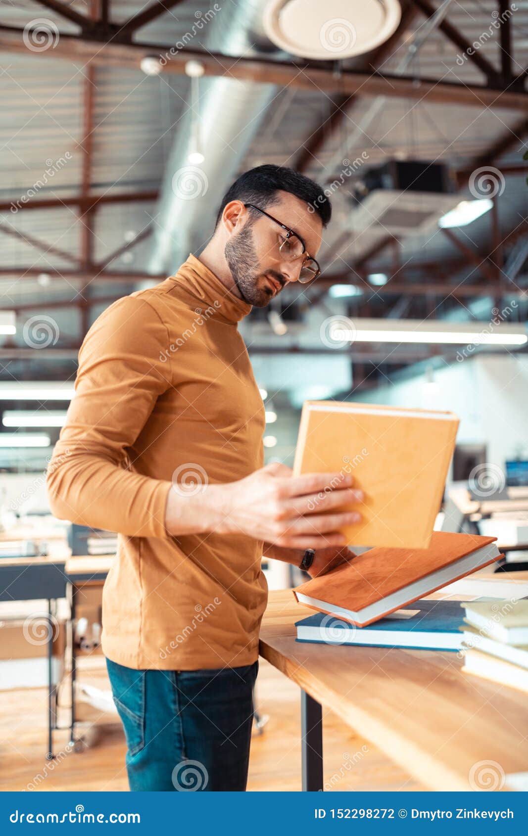 Bearded Writer Looking at the Samples of Book Covers Stock Photo ...