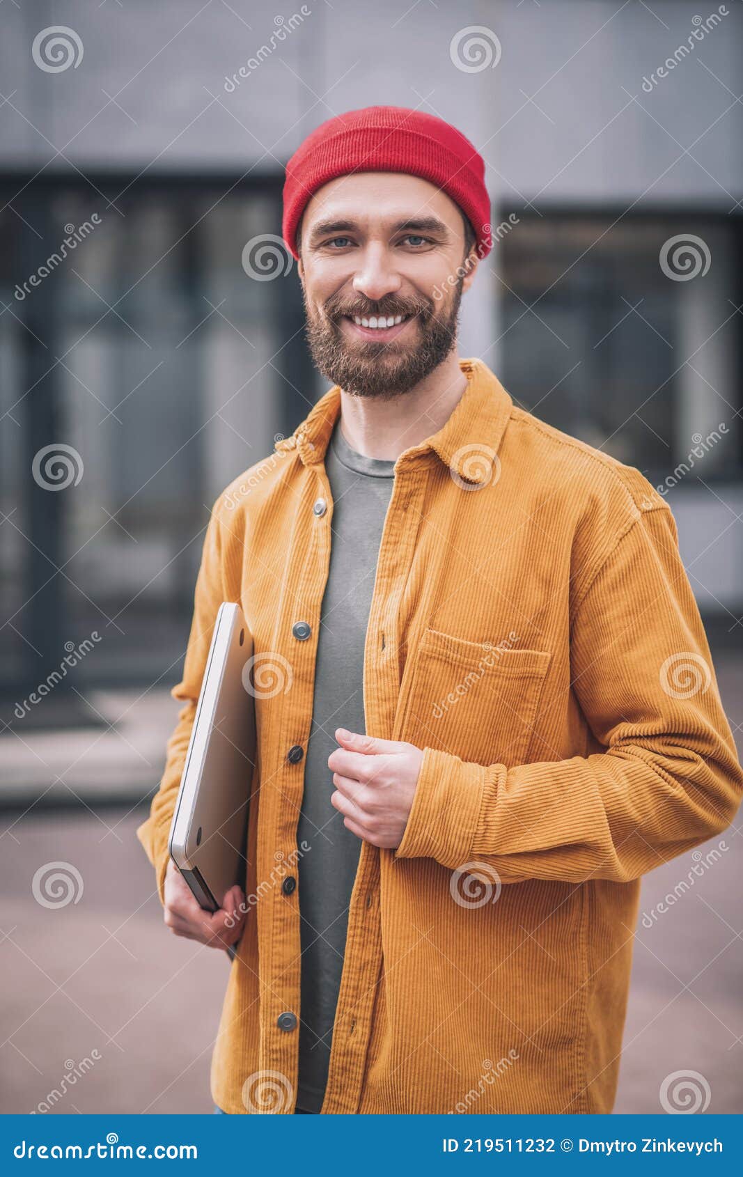 Bearded Young Man in a Red Hat with a Laptop Stock Photo - Image of ...