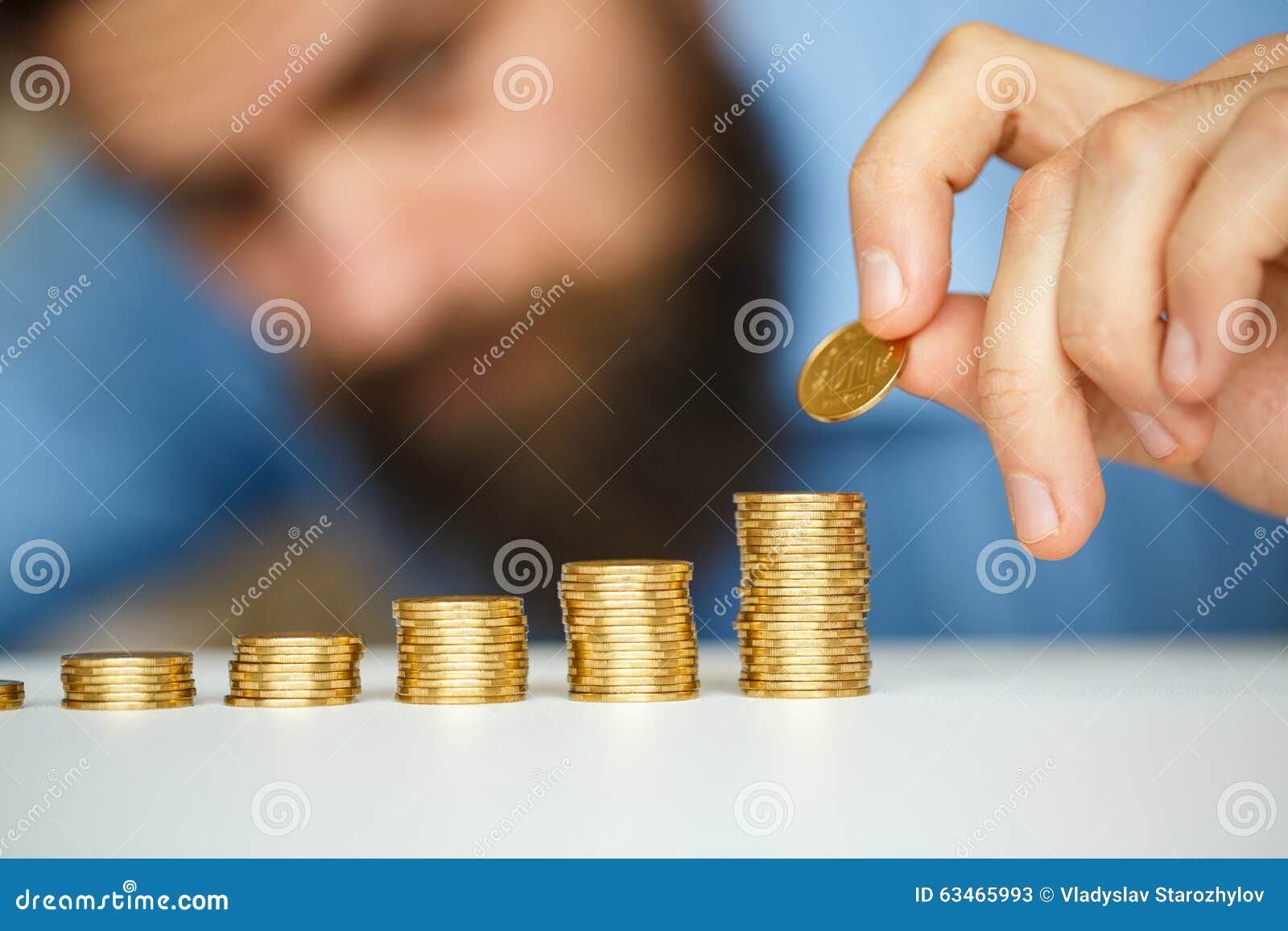Beared Man Stacking Gold Coins into Increasing Columns Stock Image ...