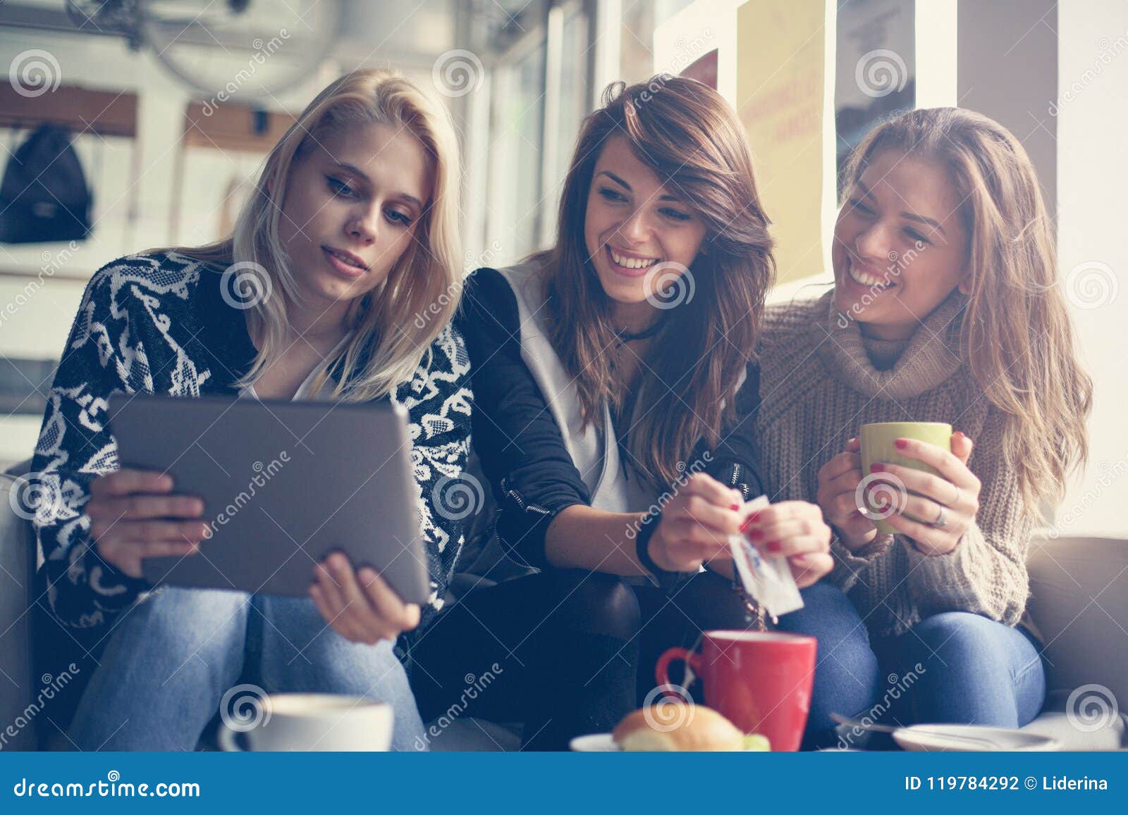 Young girls a cafe. stock photo. Image of mobile, cafe - 119784292