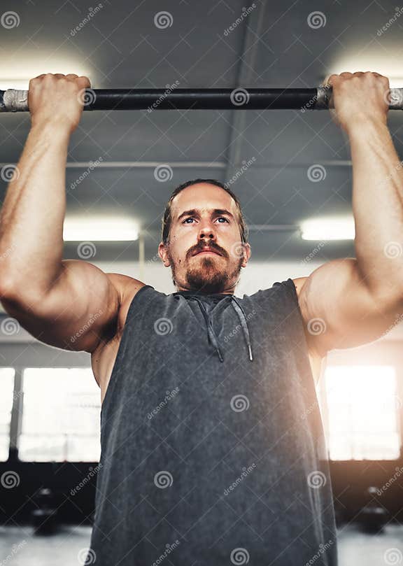 Beast Mode Activated. a Young Man Doing Pull Ups in a Gym. Stock Photo ...