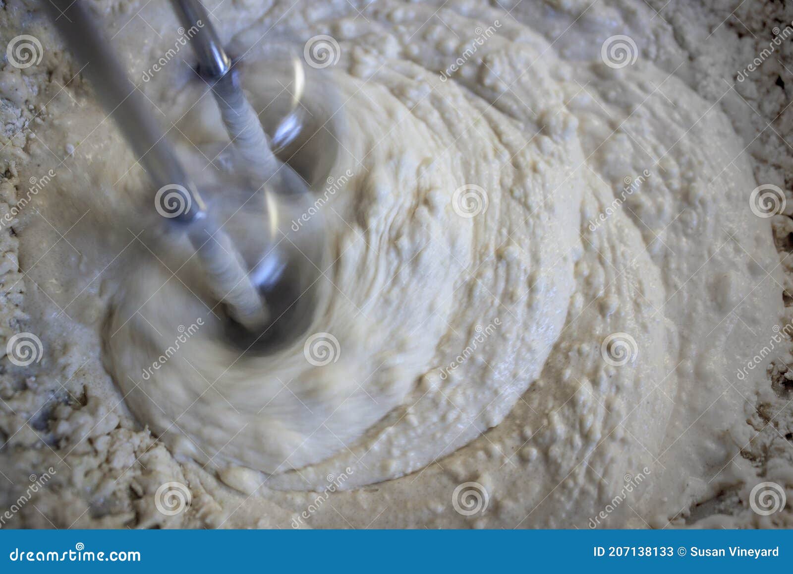 Beaters of Electric Mixer Beating Lumpy Batter in a Bowl - Closeup and ...