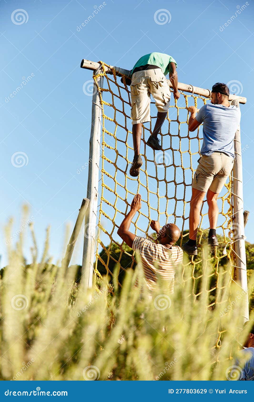 Beating the Obstacle Course. a Group of Men Going through an Obstacle ...