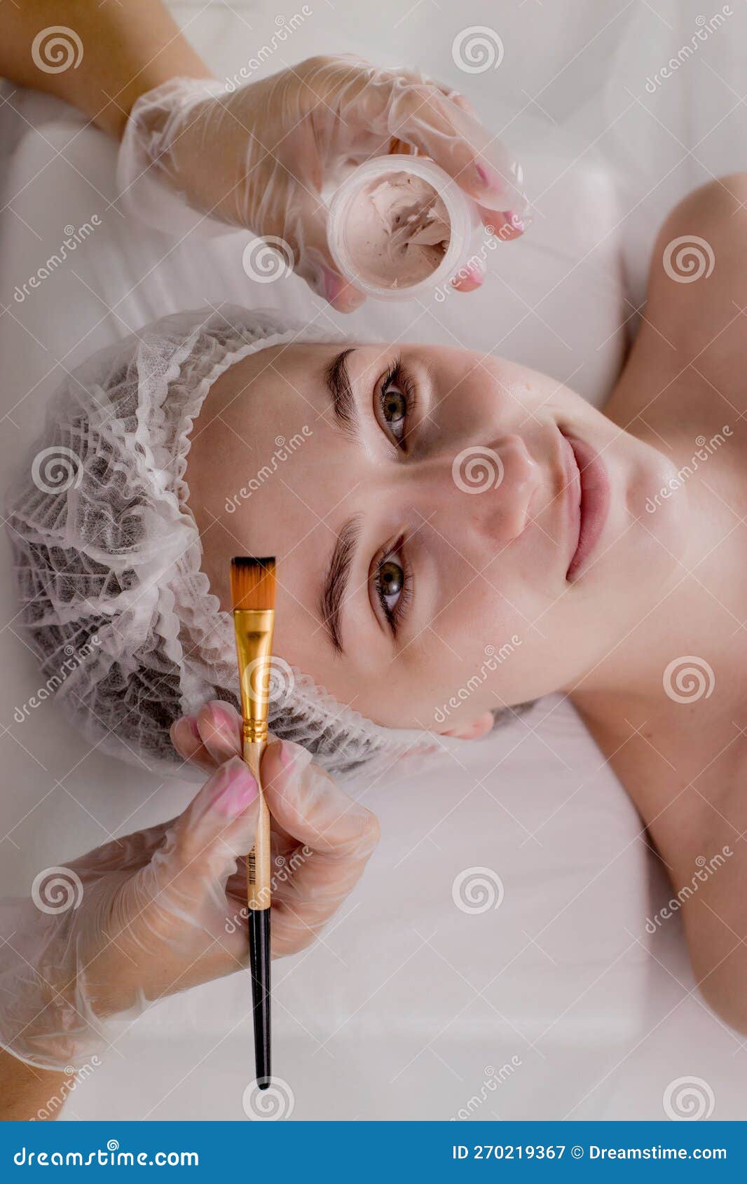 A Beautician Applies A Mask To The Skin Of A Womanand X27 S Face For