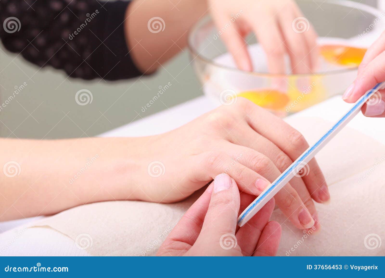 Beautician With File Filing Nails Female Client Woman Spa Beauty Salon
