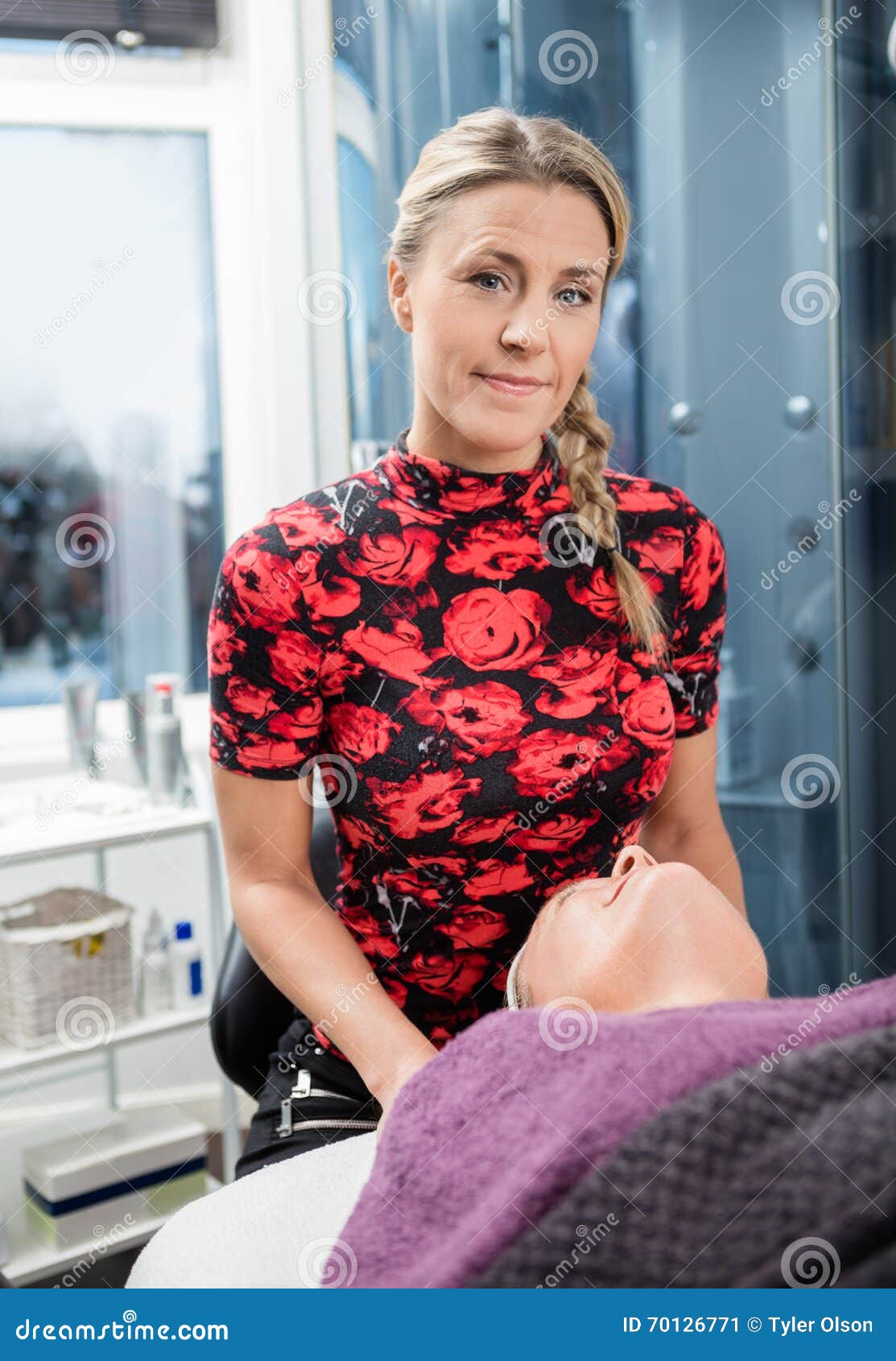 Beautician Sitting By Client Undergoing Facial Treatment Stock Image