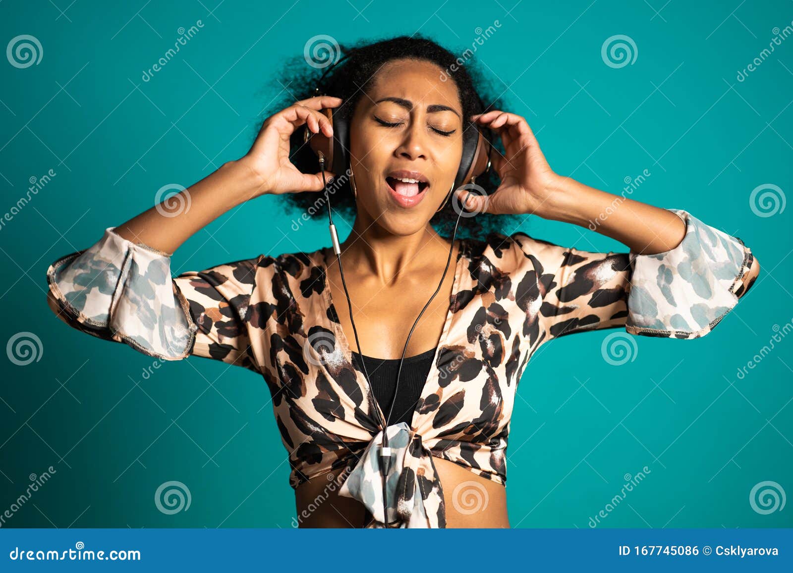 Beautiful African American Woman With Afro Hair And Big Headphones