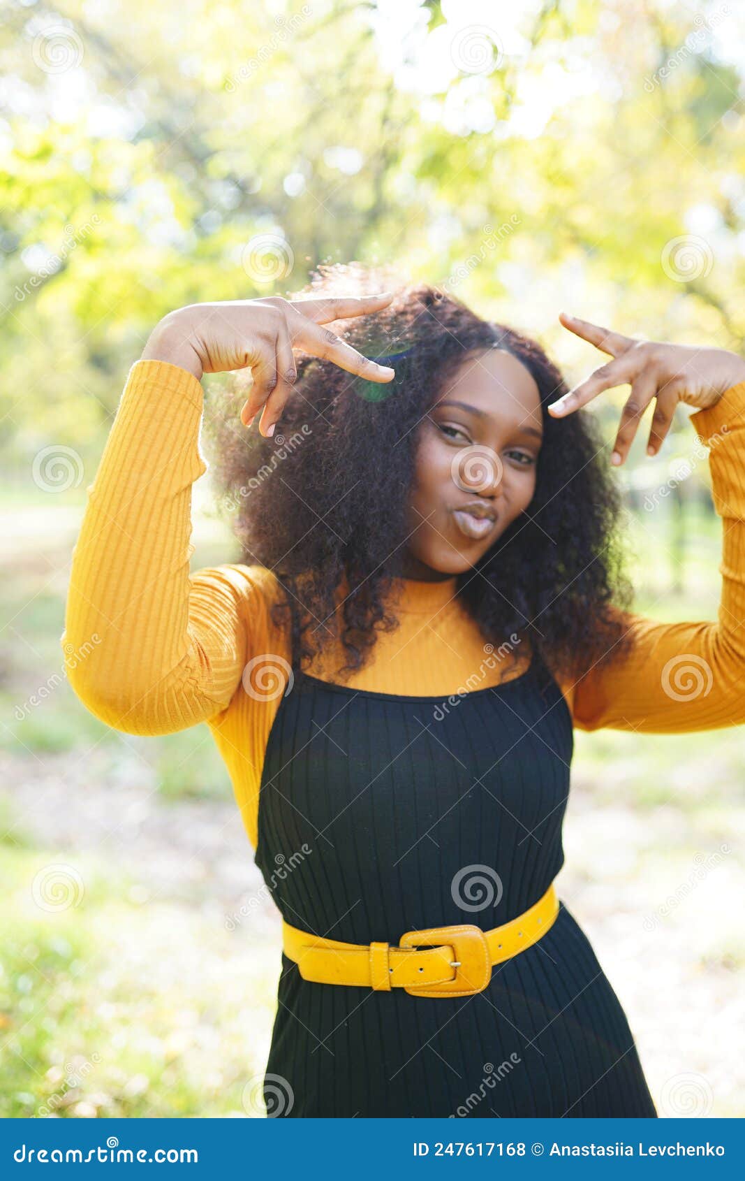 Beautiful African American Woman Smiling In The Park During Sunset