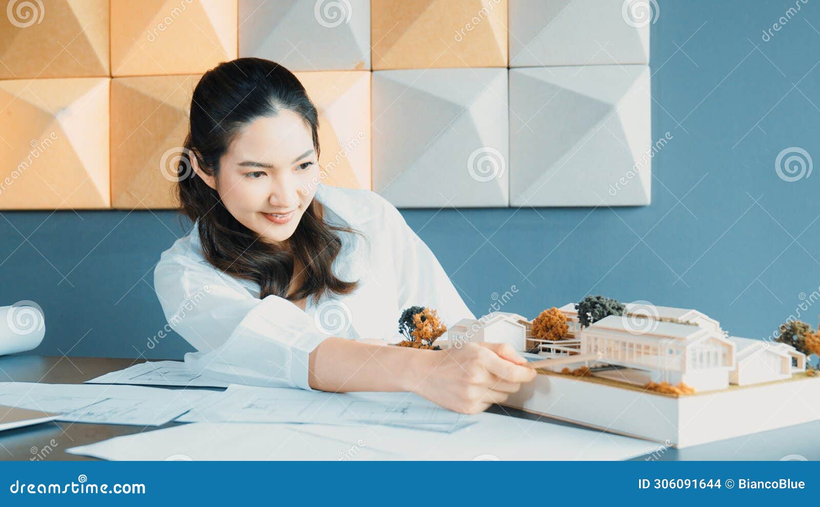 Beautiful Architect Measuring House Model while Taking a Note ...
