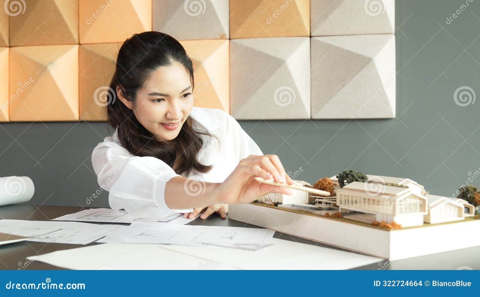 Beautiful Architect Measuring House Model while Taking a Note ...