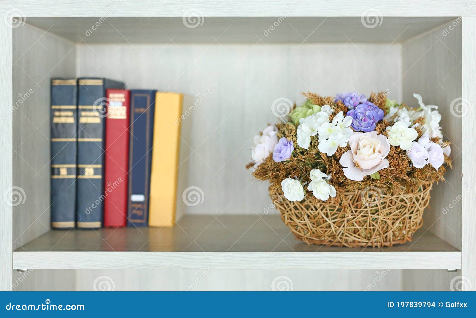 Beautiful Artificial Rose Flower in Basket on the Bookshelf in Library ...