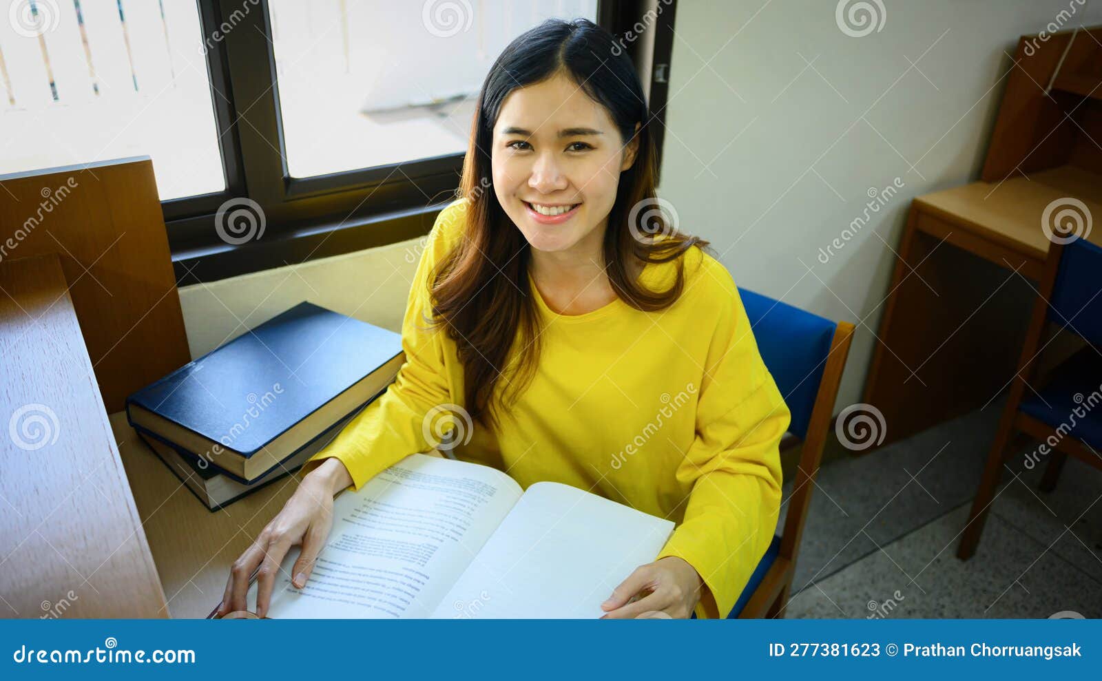 Beautiful Asian Female Student Reading Book, Doing Class Assignment. in ...