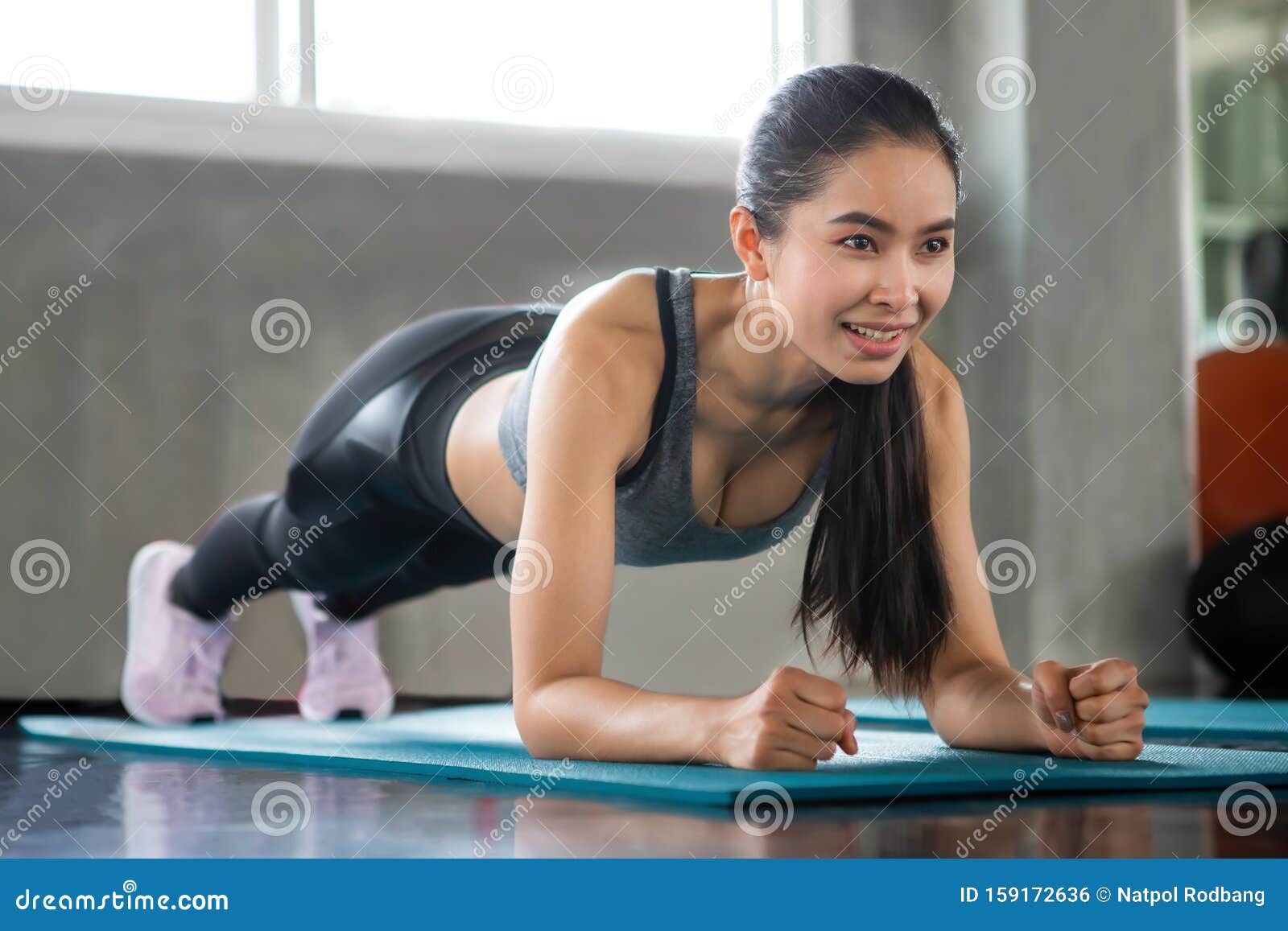 Beautiful Asian Fitness Young Woman In Sportswear Doing Plank In Gym