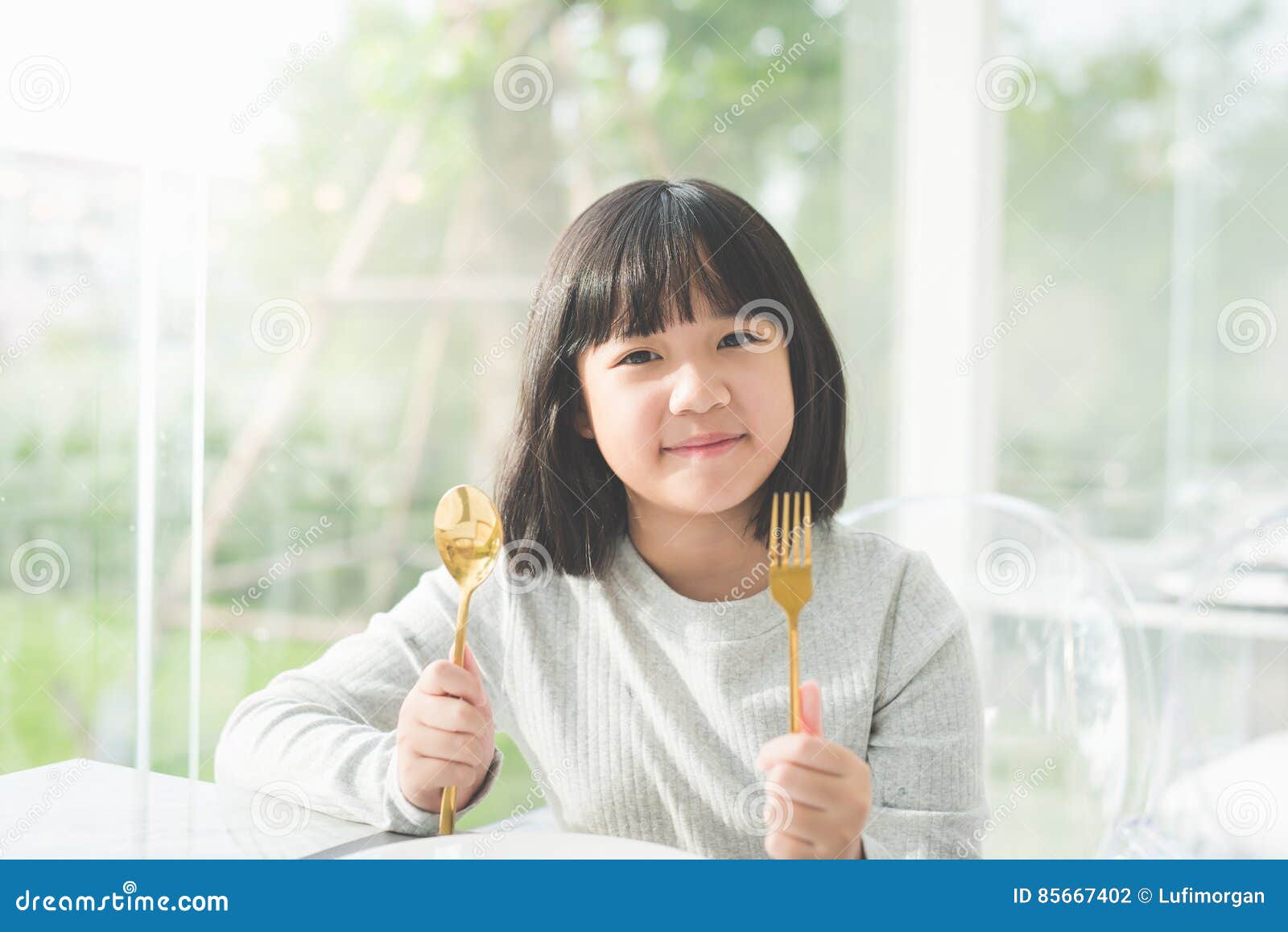 Beautiful Asian Girl Holding a Spoon and Fork Stock Photo - Image of ...