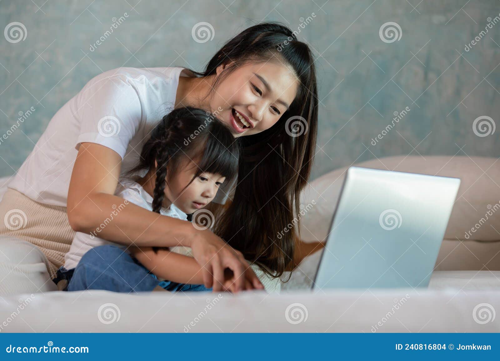 Beautiful Asian Mom Teaching Her Daughter To Learn And Using Computer