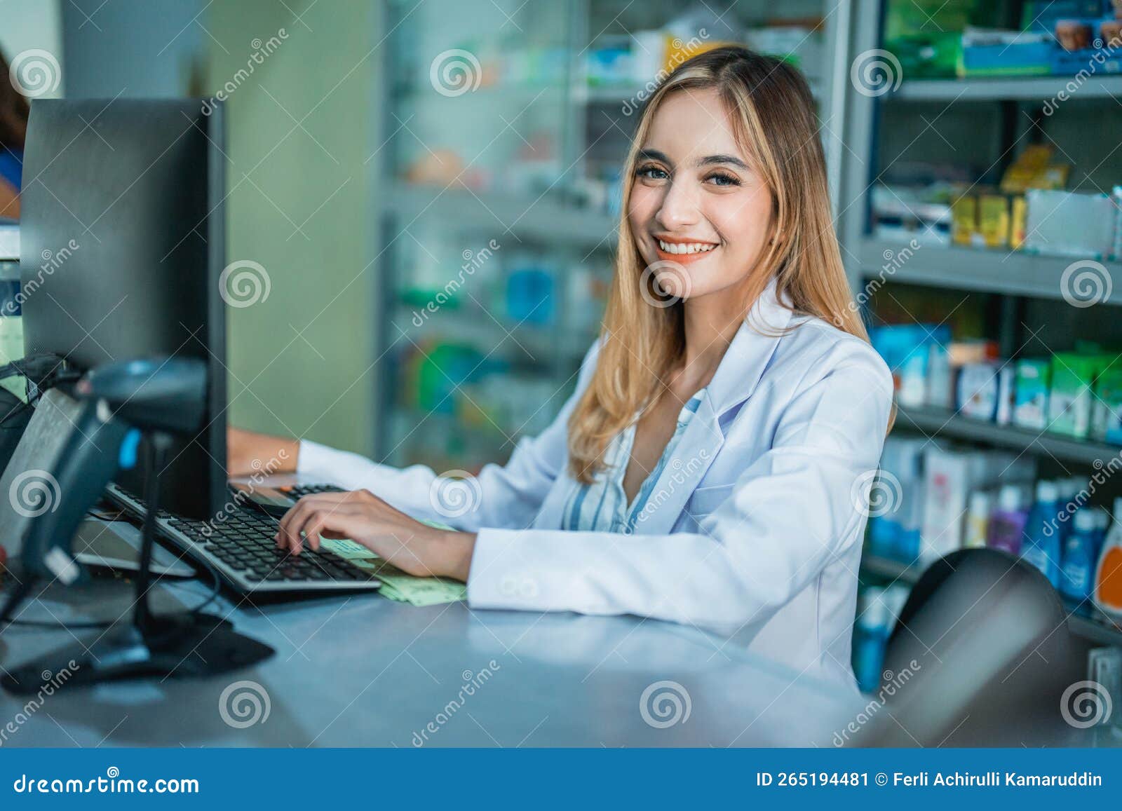 Beautiful Asian Pharmacist in Uniform Smiling while Working Using ...