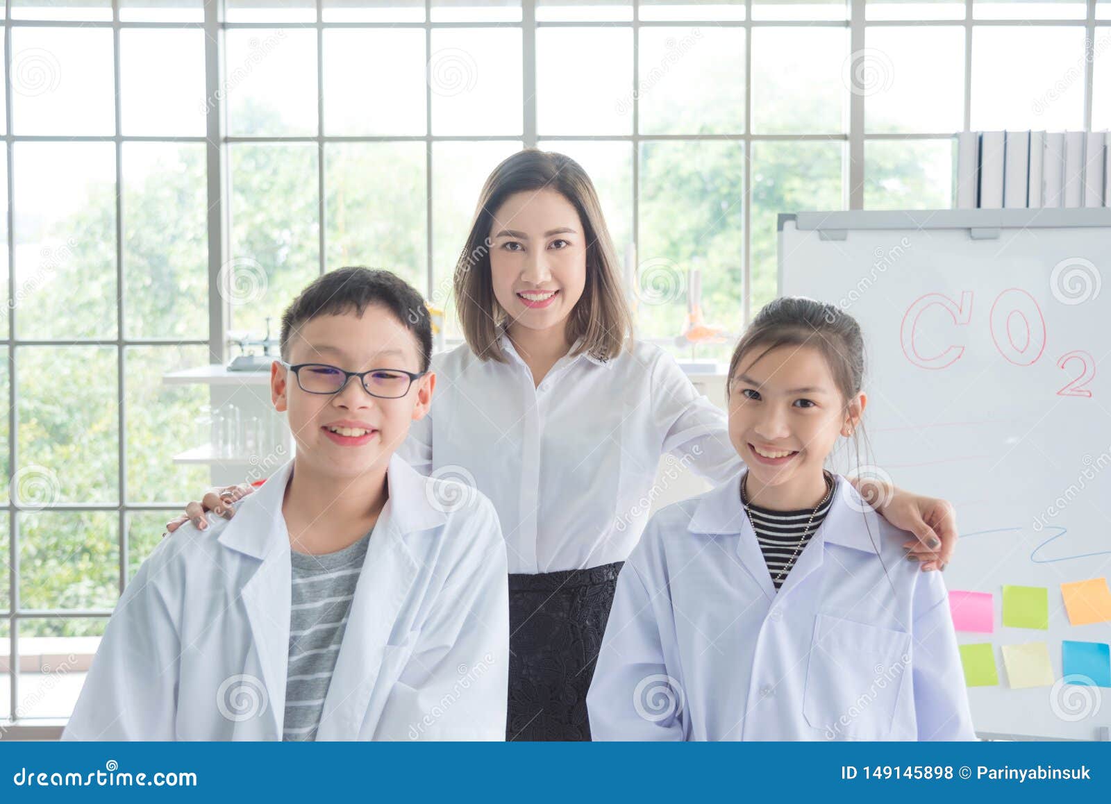 Teacher Smiling with Her Student in Classroom Stock Photo - Image of ...