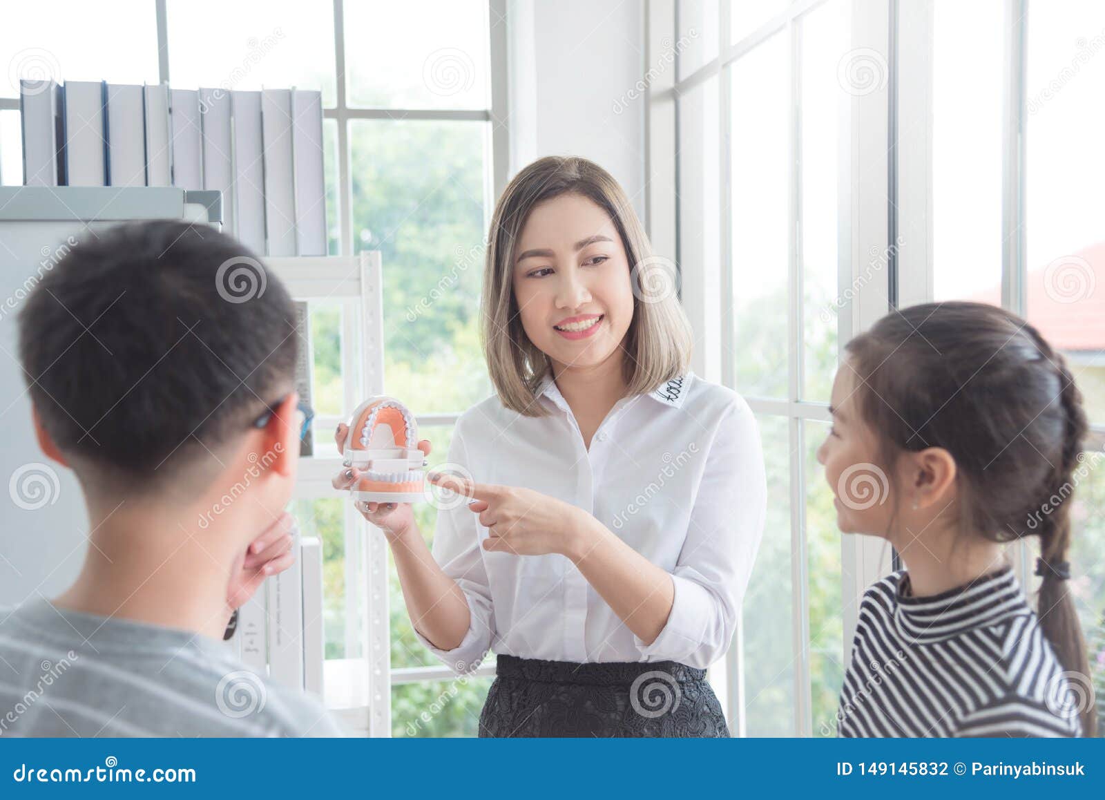 Teacher Teaching Her Student about Teeth in Classroom Stock Photo ...