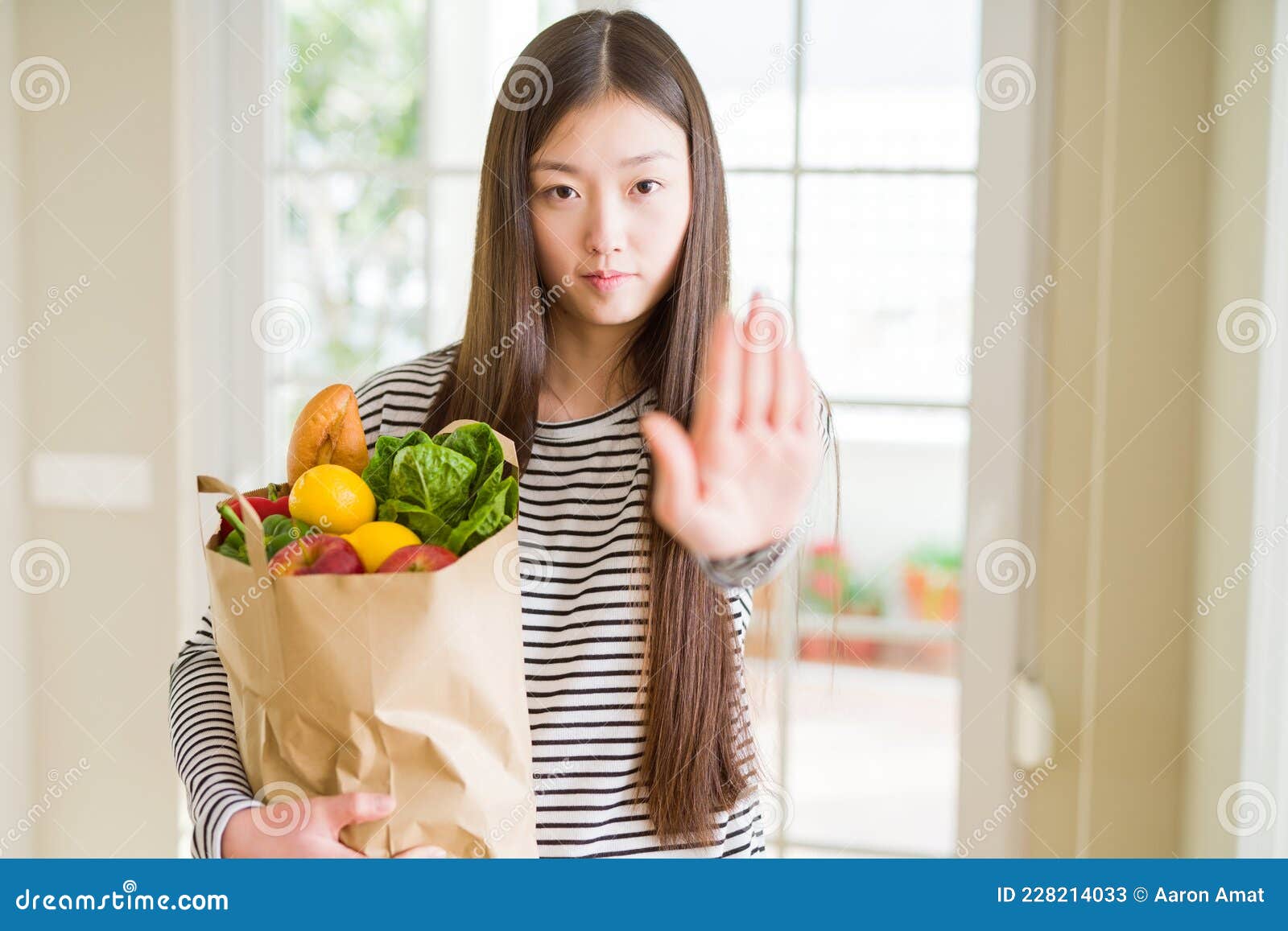 Beautiful Asian Woman Holding Paper Bag Of Fresh Groceries With Open