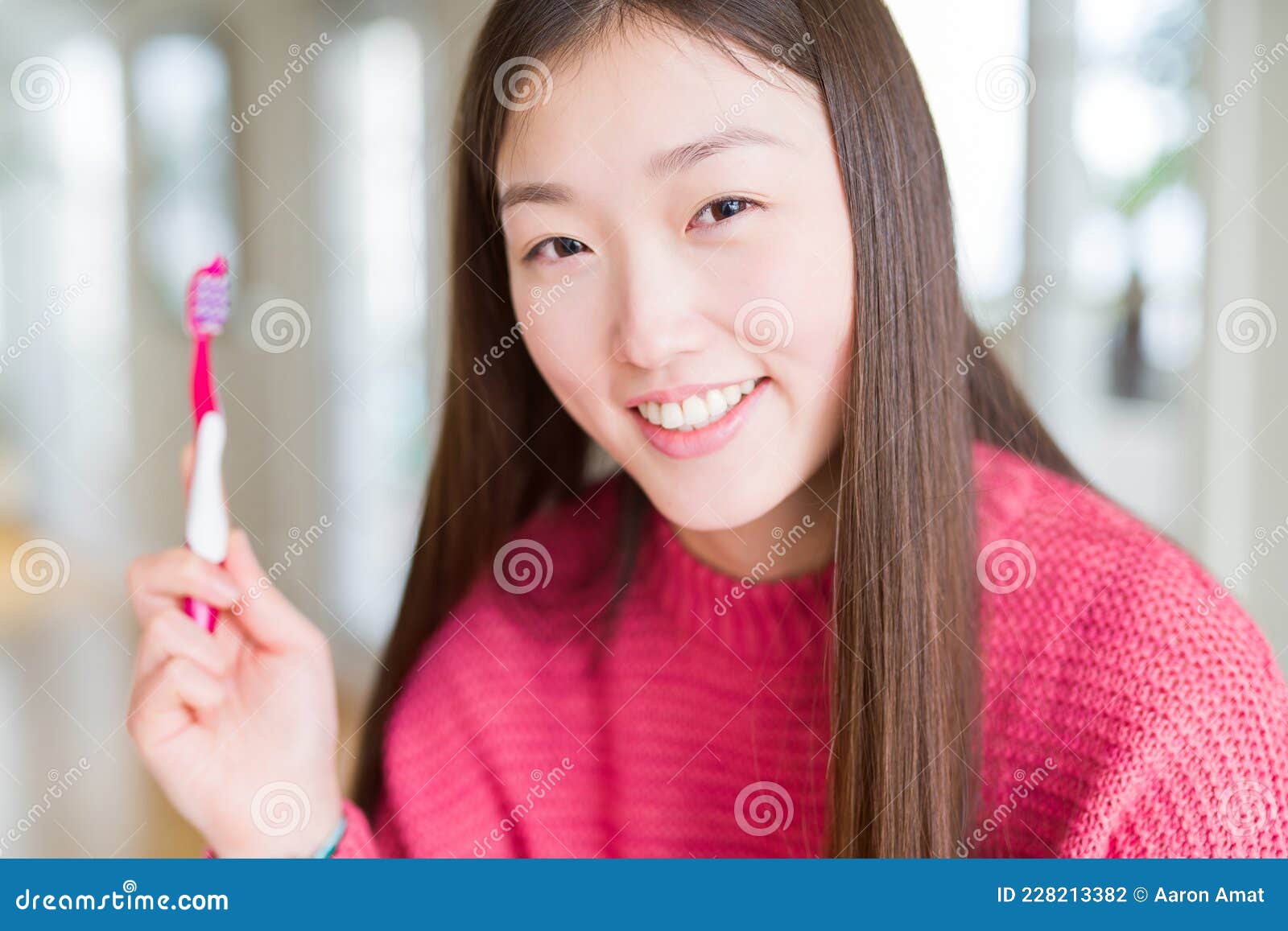 Beautiful Asian Woman Holding Toothbrush With A Happy Face Standing And