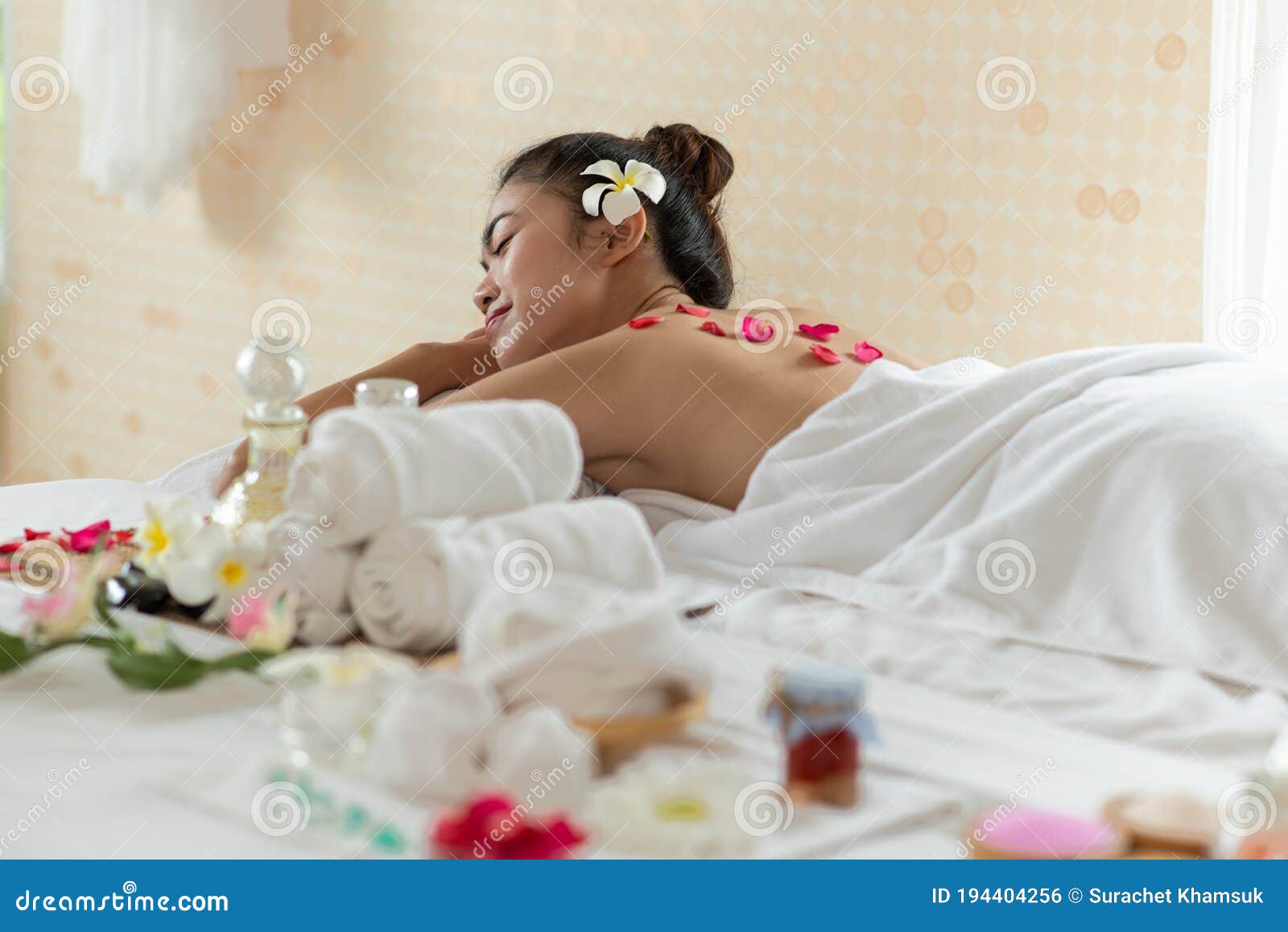 Beautiful Asian Woman Lying Down On Massage Bed Relaxing In Spa Salon