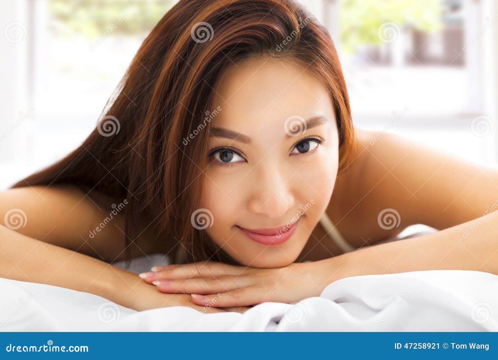 Beautiful Asian Woman Relaxing on the Bed with Sunlight Ba Stock Image ... Beautiful Asian Woman Relaxing on the Bed with Sunlight Ba Stock Image ...