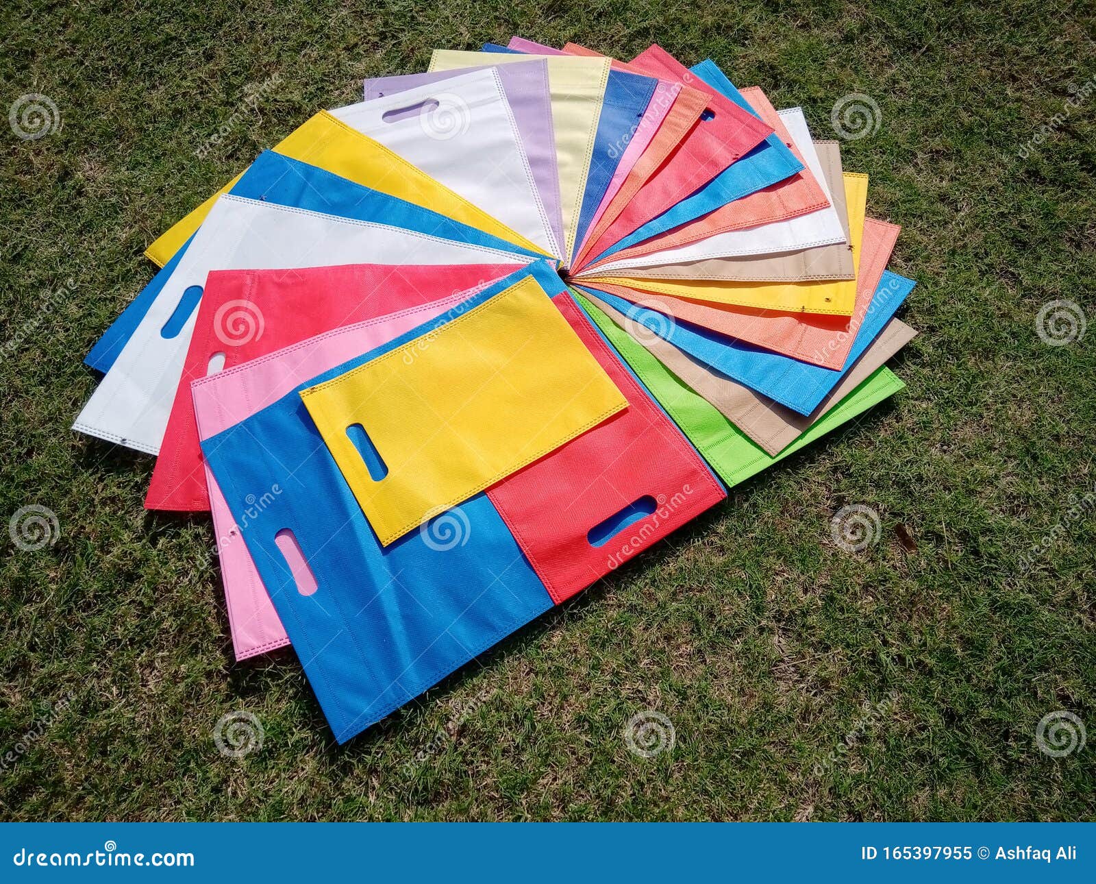 Beautiful Assorted Color Fabric Bags on Grass Stock Image - Image of ...