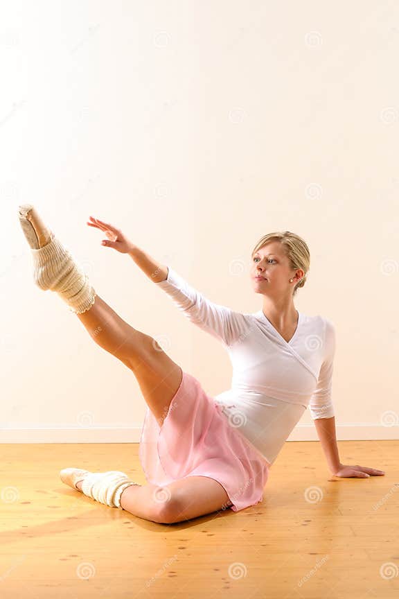 Beautiful Ballet Dancer Lifting Arm Towards Leg Stock Image - Image of ...