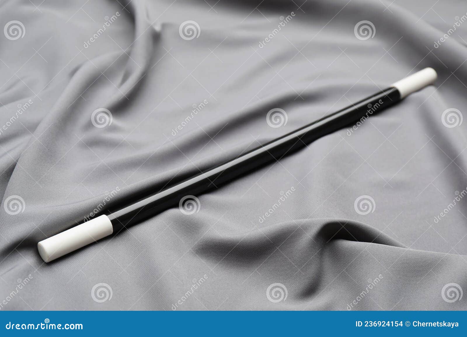 Beautiful Black Magic Wand on Grey Fabric Stock Photo - Image of ...