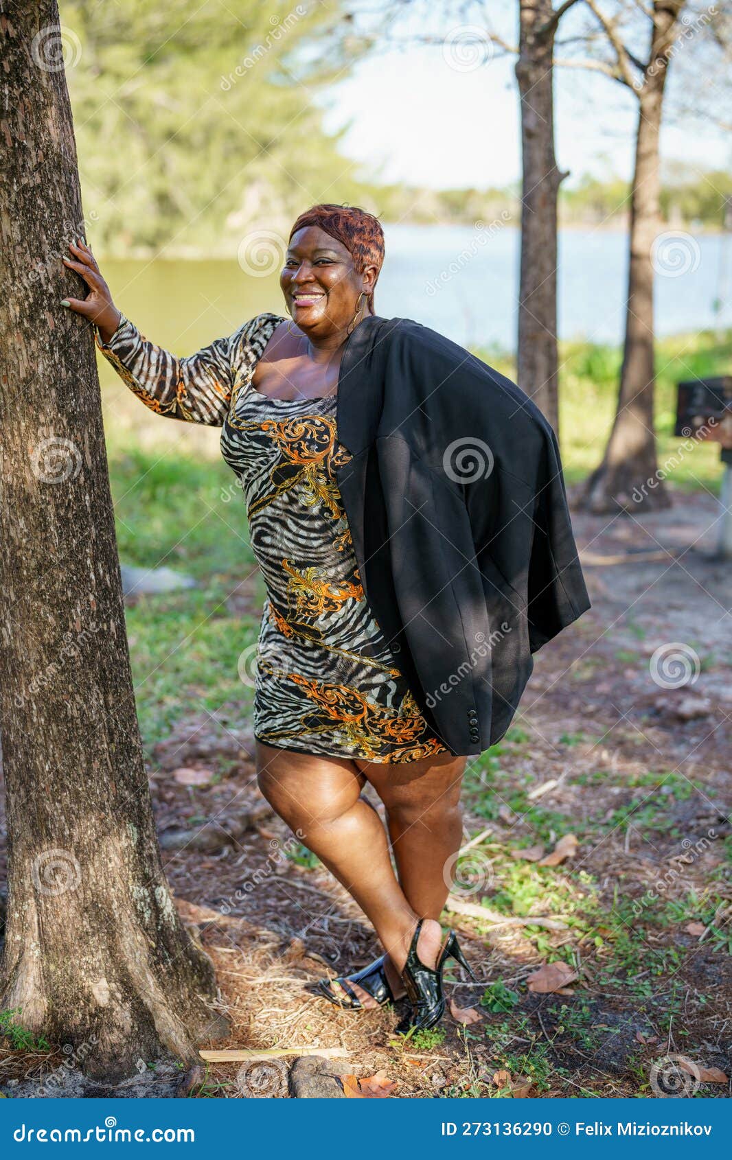 Beautiful Black Plus Sized Model Posing by a Tree in a Tranquil Park ...