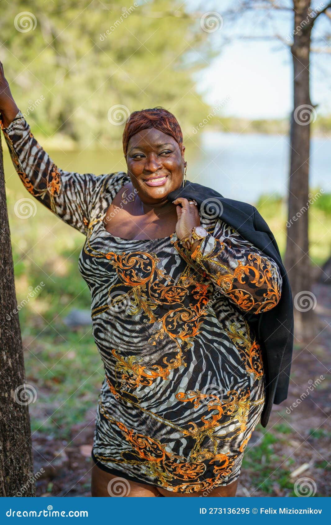 Beautiful Black Plus Sized Model Posing By A Tree In A Tranquil Park ...