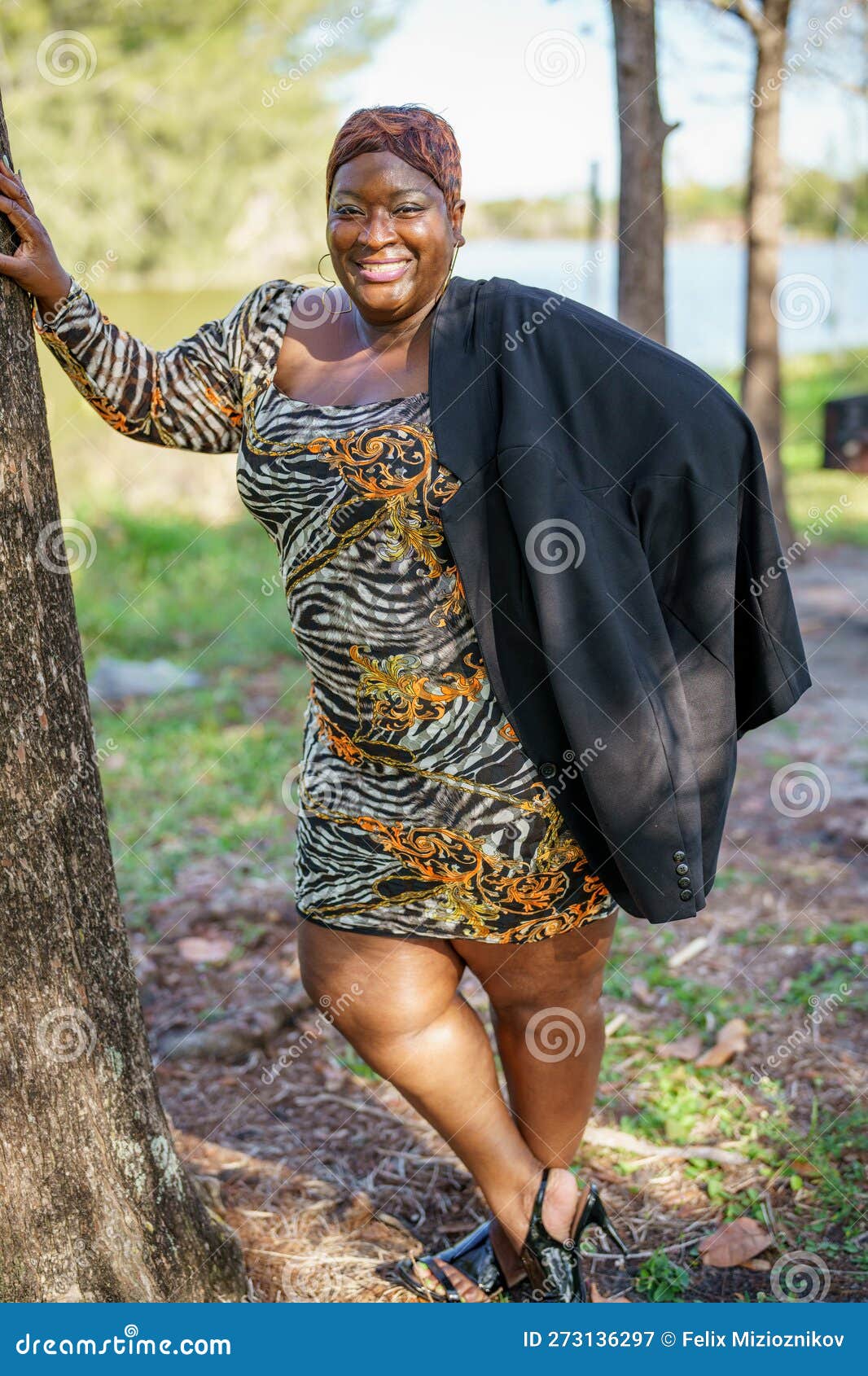 Beautiful Black Plus Sized Model Posing by a Tree in a Tranquil Park ...