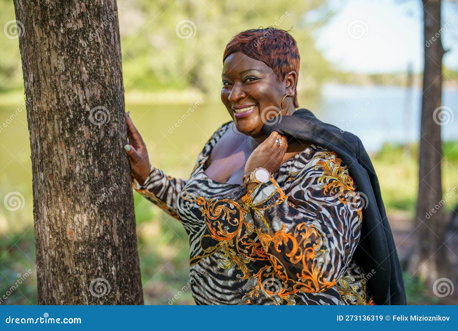 Beautiful Black Plus Sized Model Posing by a Tree in a Tranquil Park ...