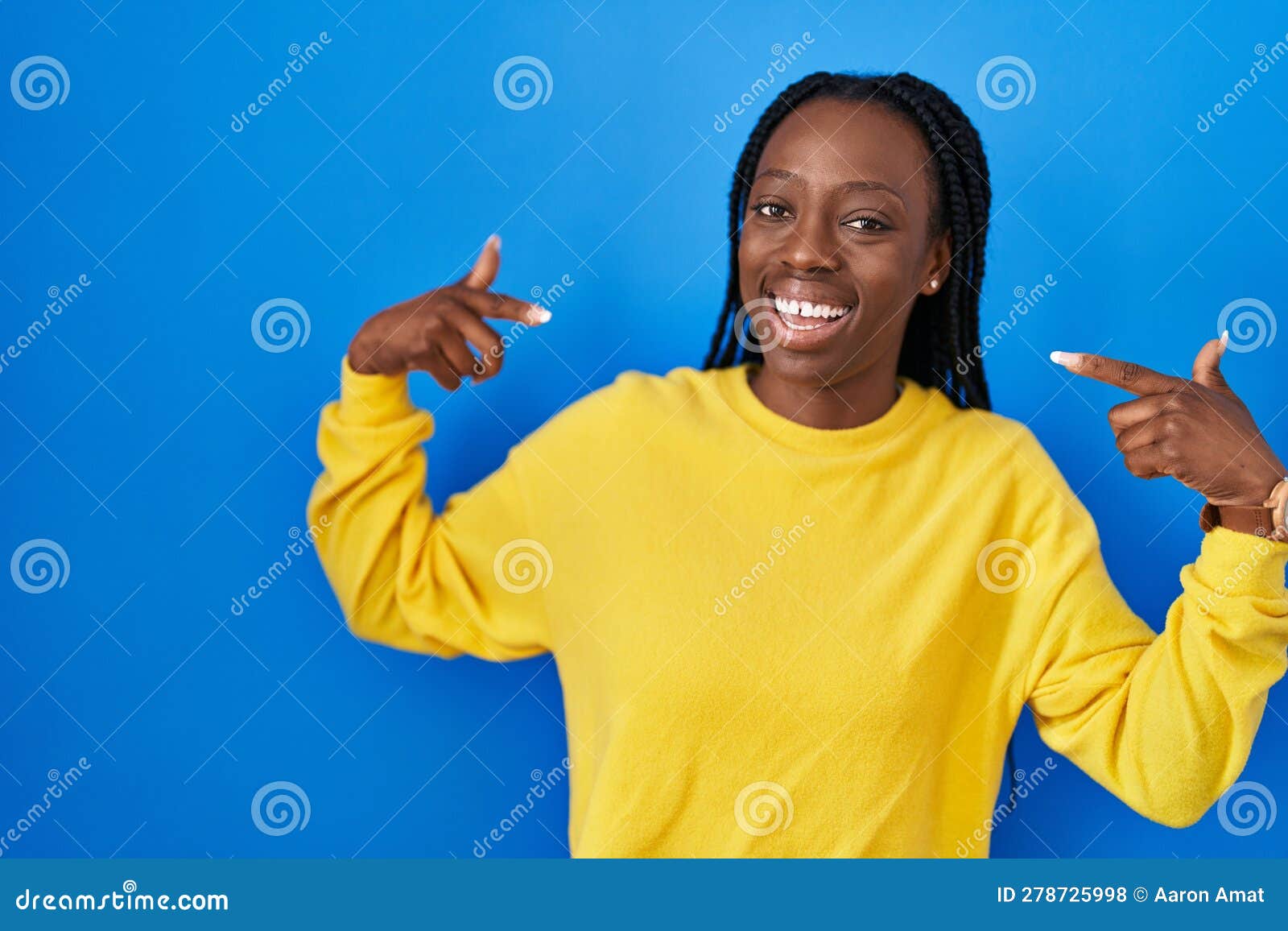 Beautiful Black Woman Standing Over Blue Background Looking Confident